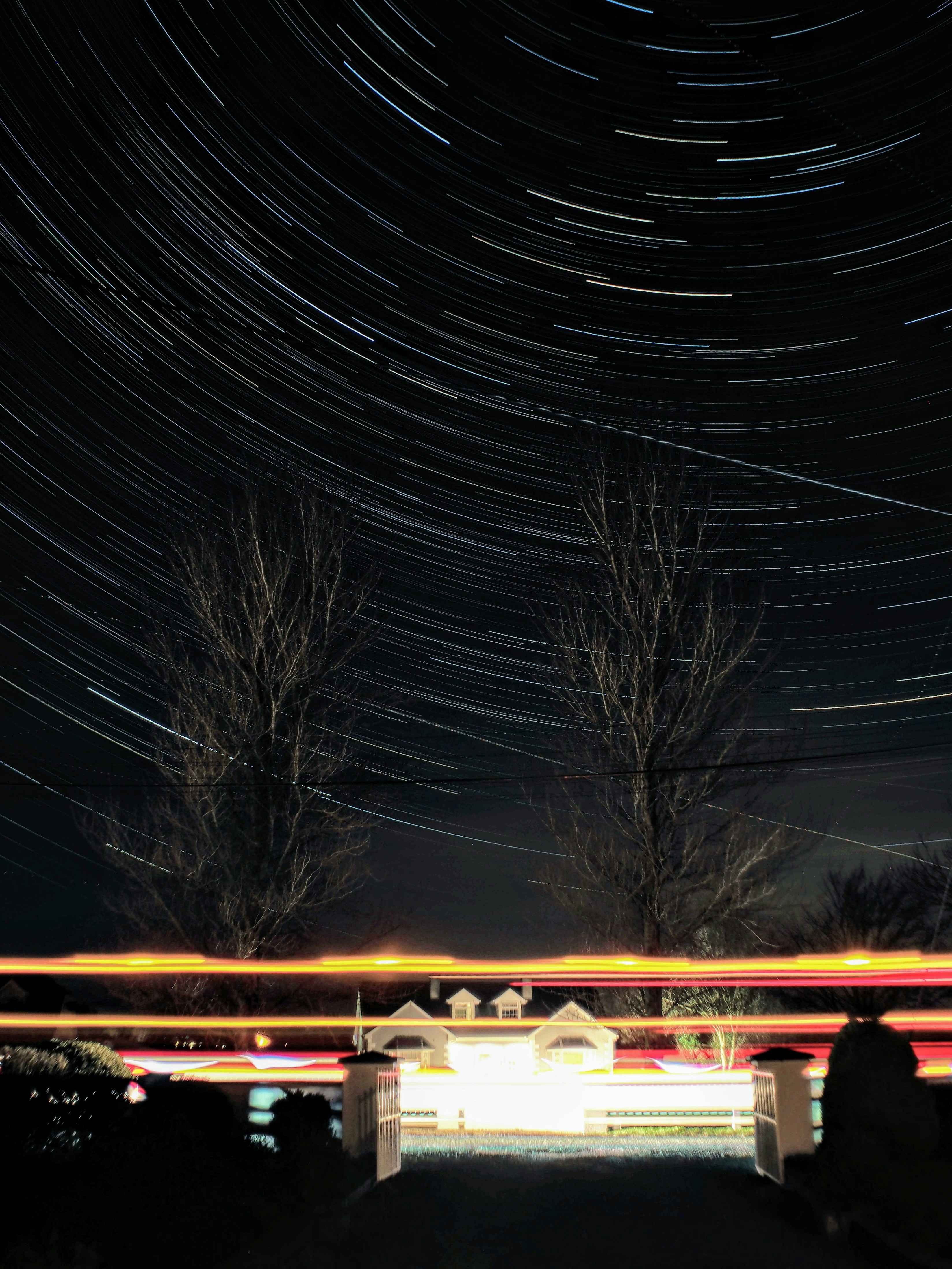 Star Trails Over a Suburban Gate: A Long-Exposure Nightscape