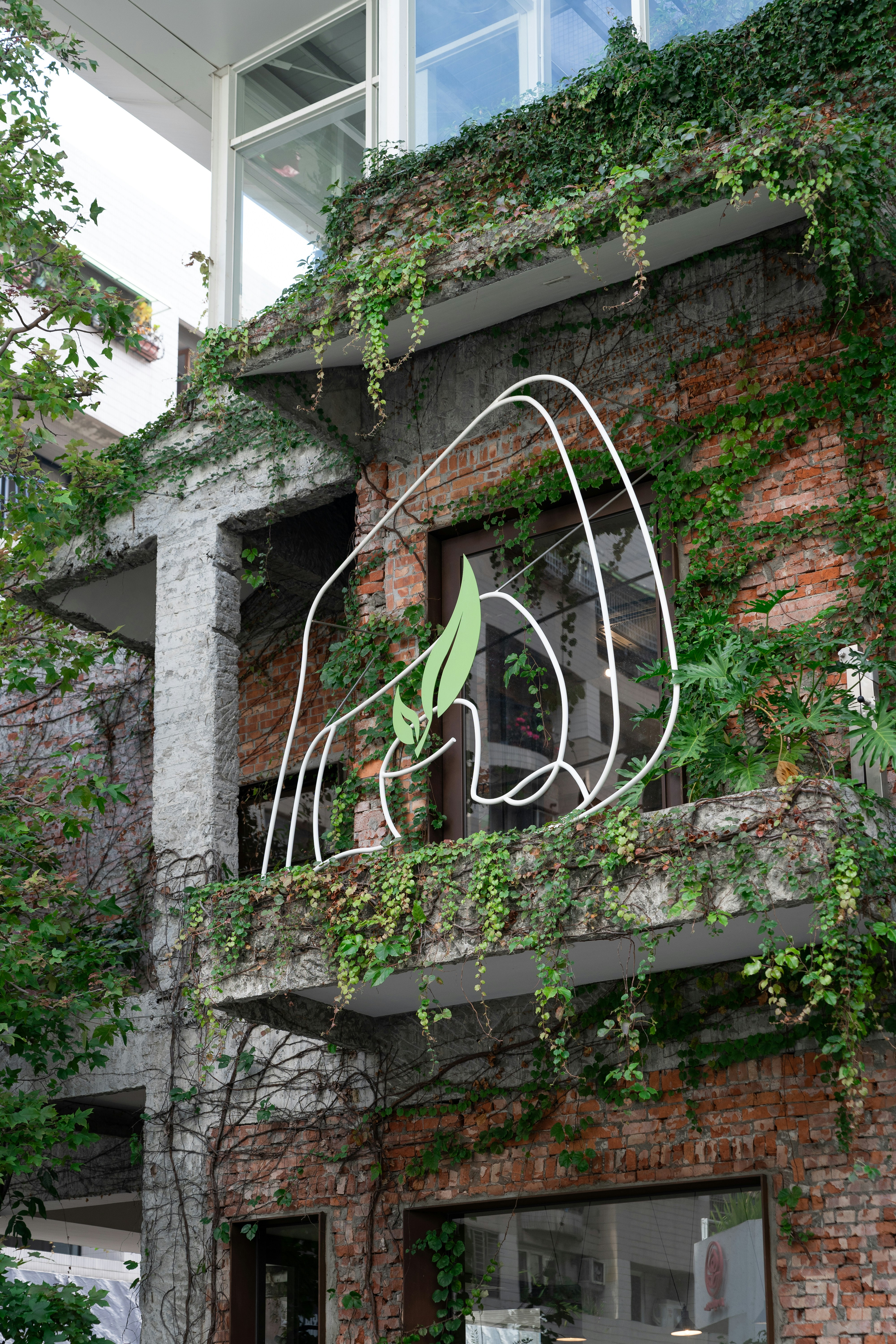 Neon Contours Amid Ivy: An Abstract Balcony Sculpture