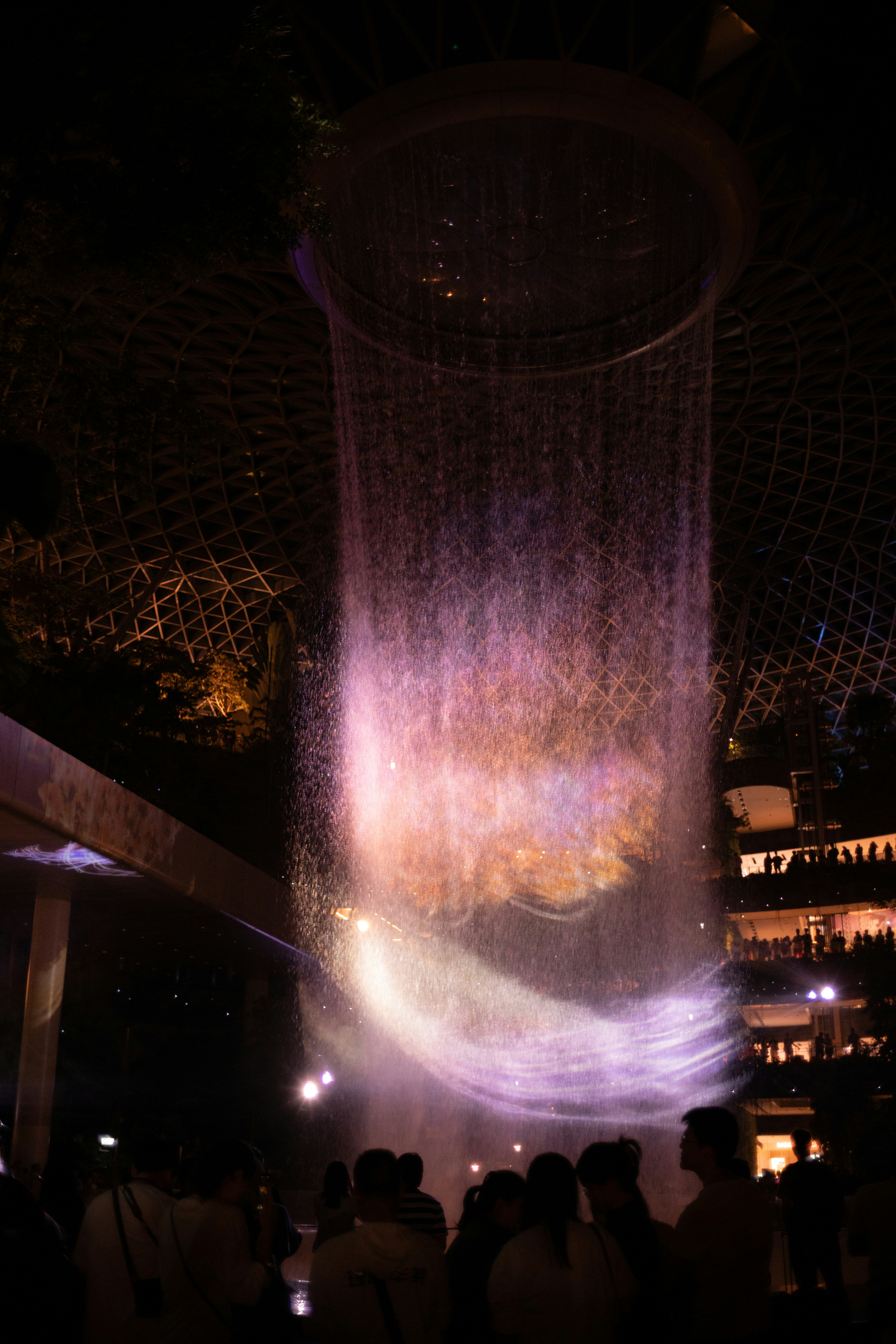 Nightfall at the Cascade: A Waterfall of Light in a Crowded Atrium
