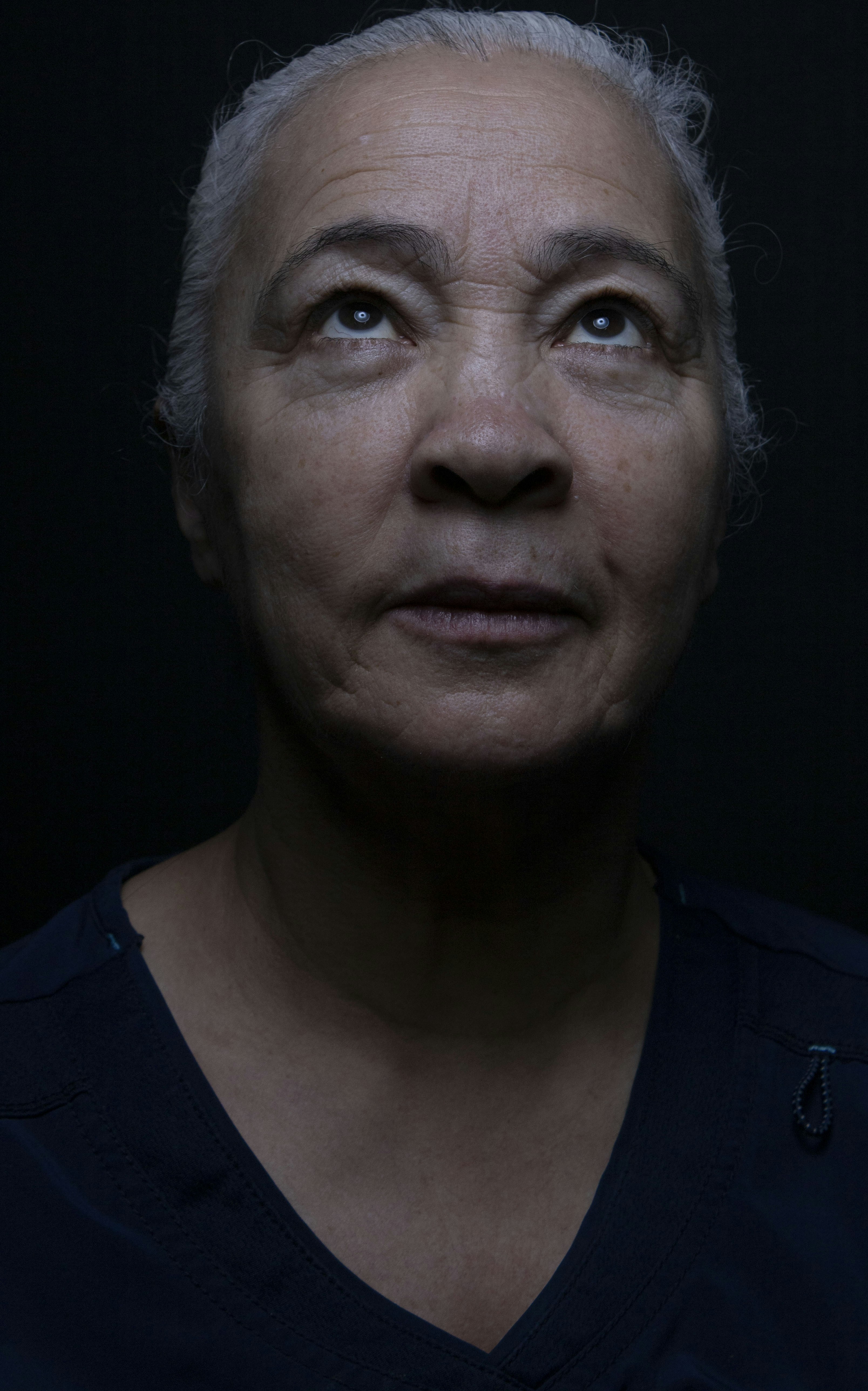 An older woman looks upward towards the light. photo – Free Raw ...
