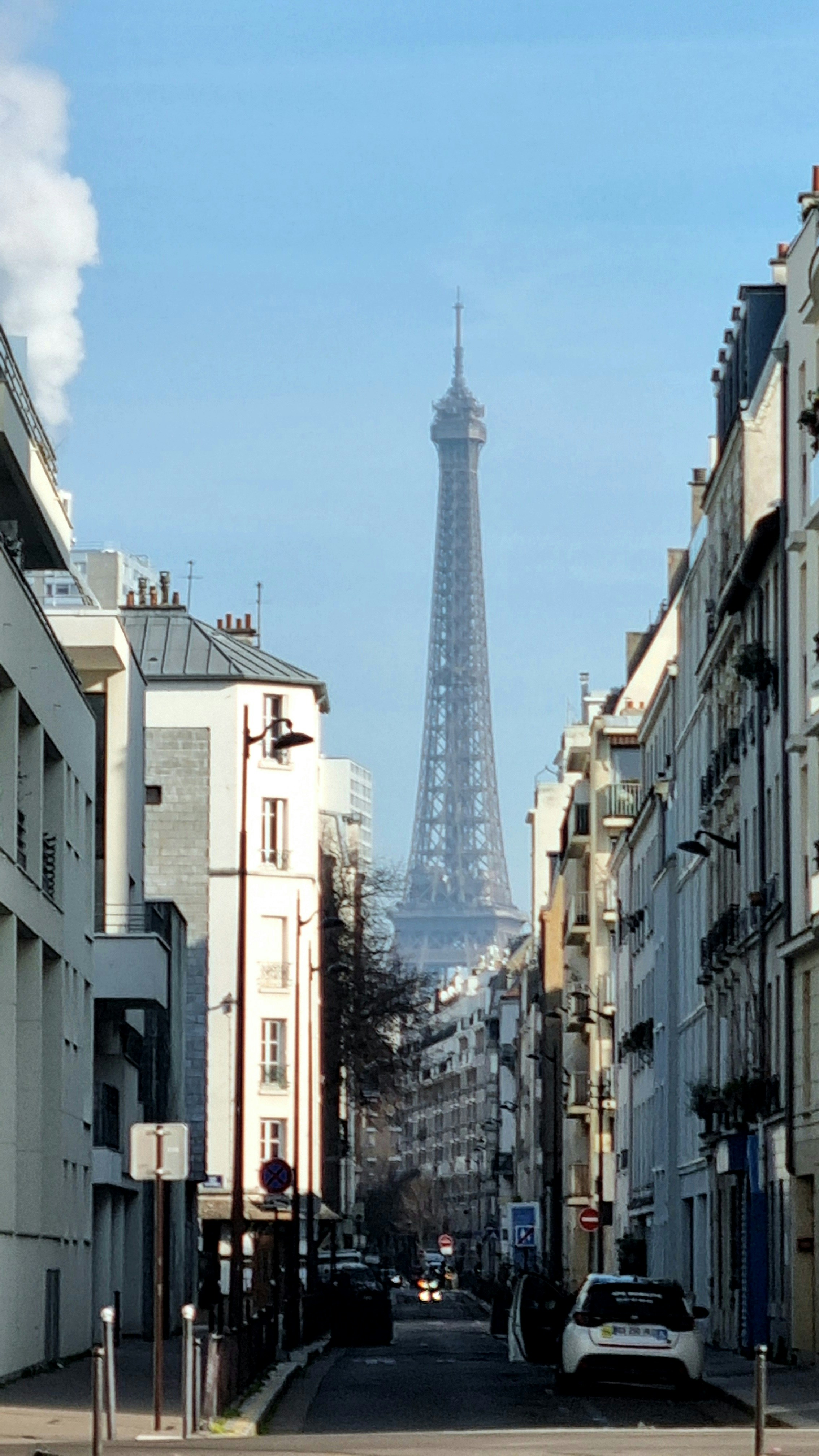 Towering City Through a Parisian Street
