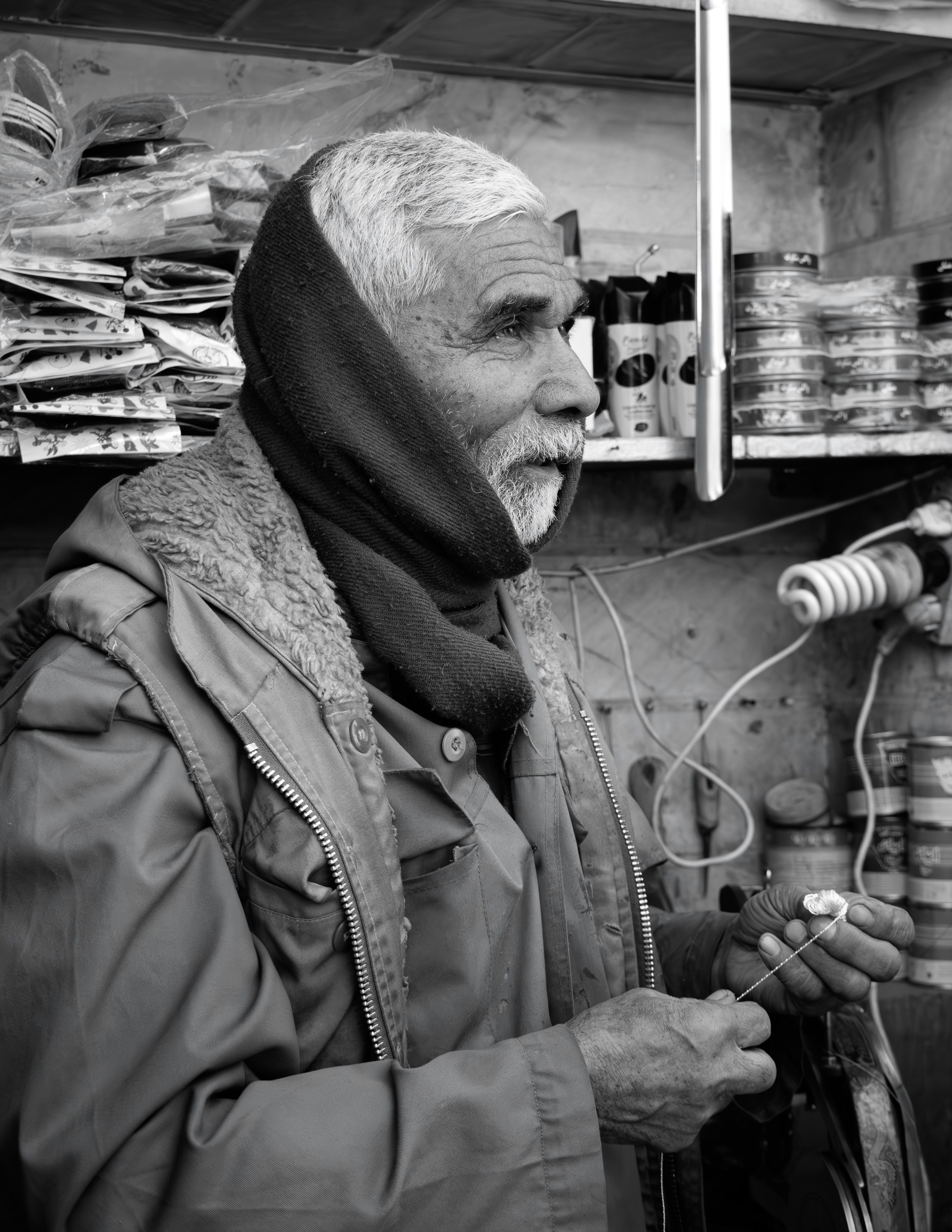 Profile in a Cluttered Workshop: Weathered Hands and Quiet Focus