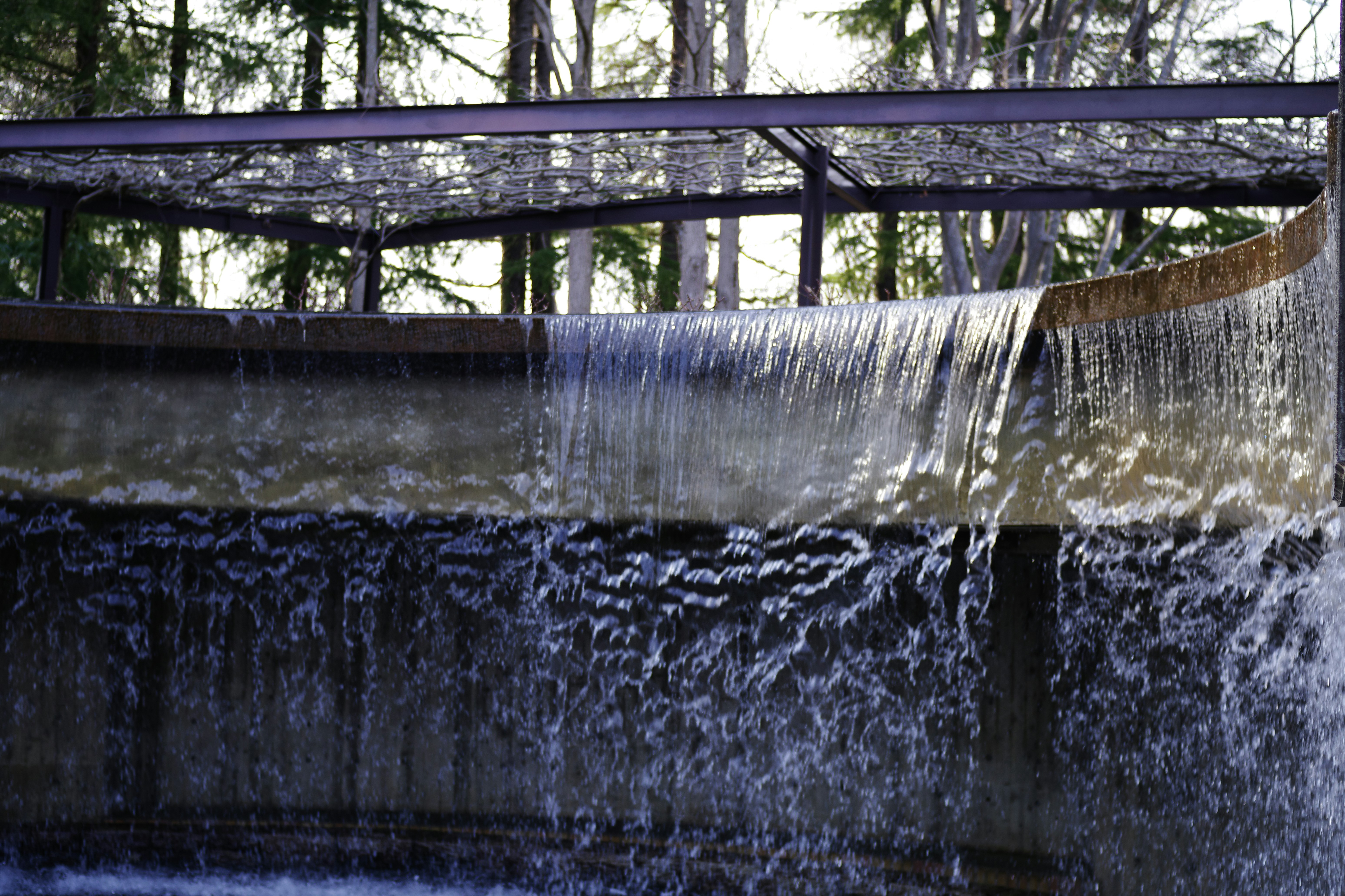 Water cascades over a man-made waterfall structure. photo – Free Forest ...