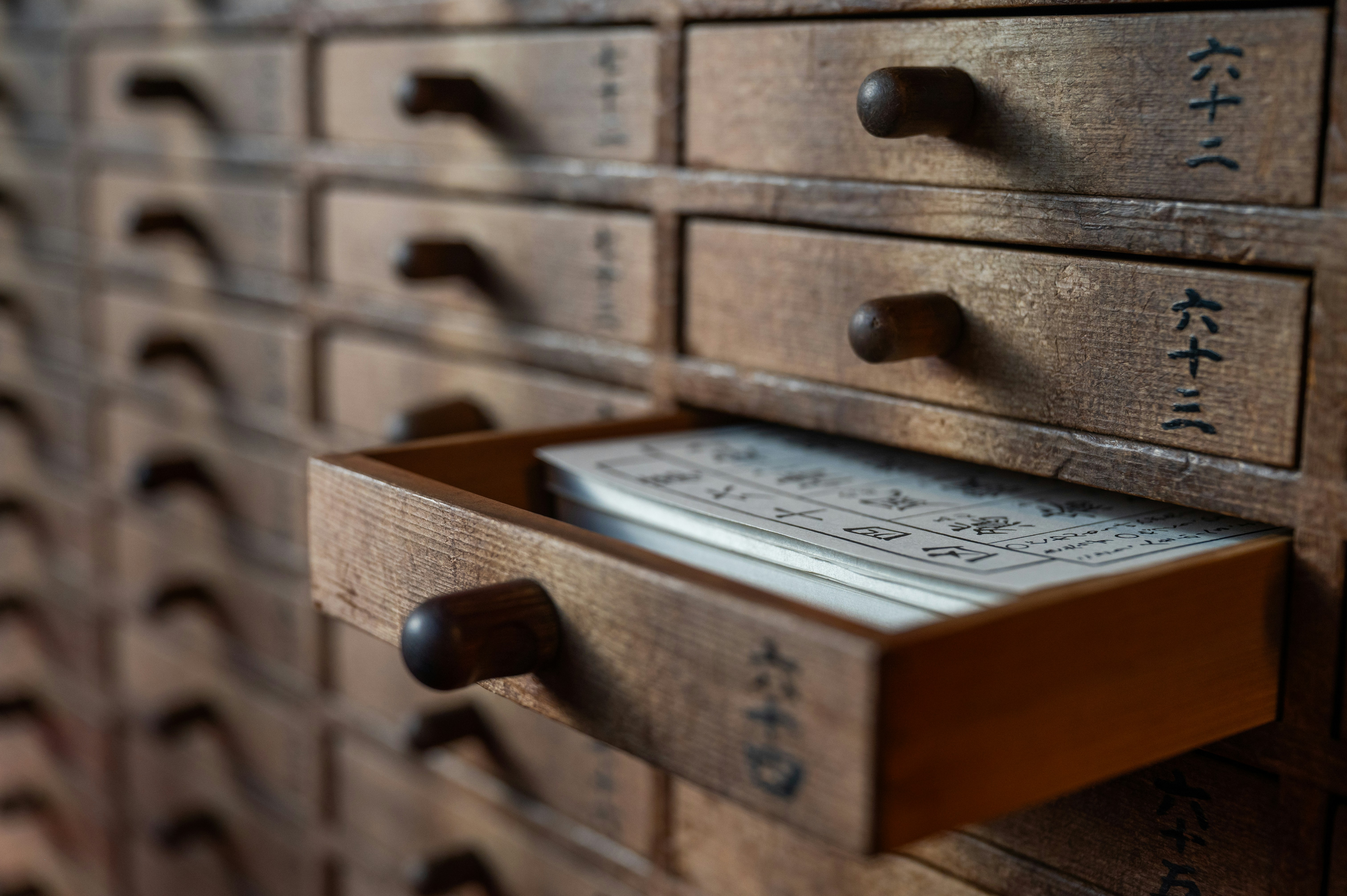 Wooden drawers contain a book with asian script. photo – Free Japan ...
