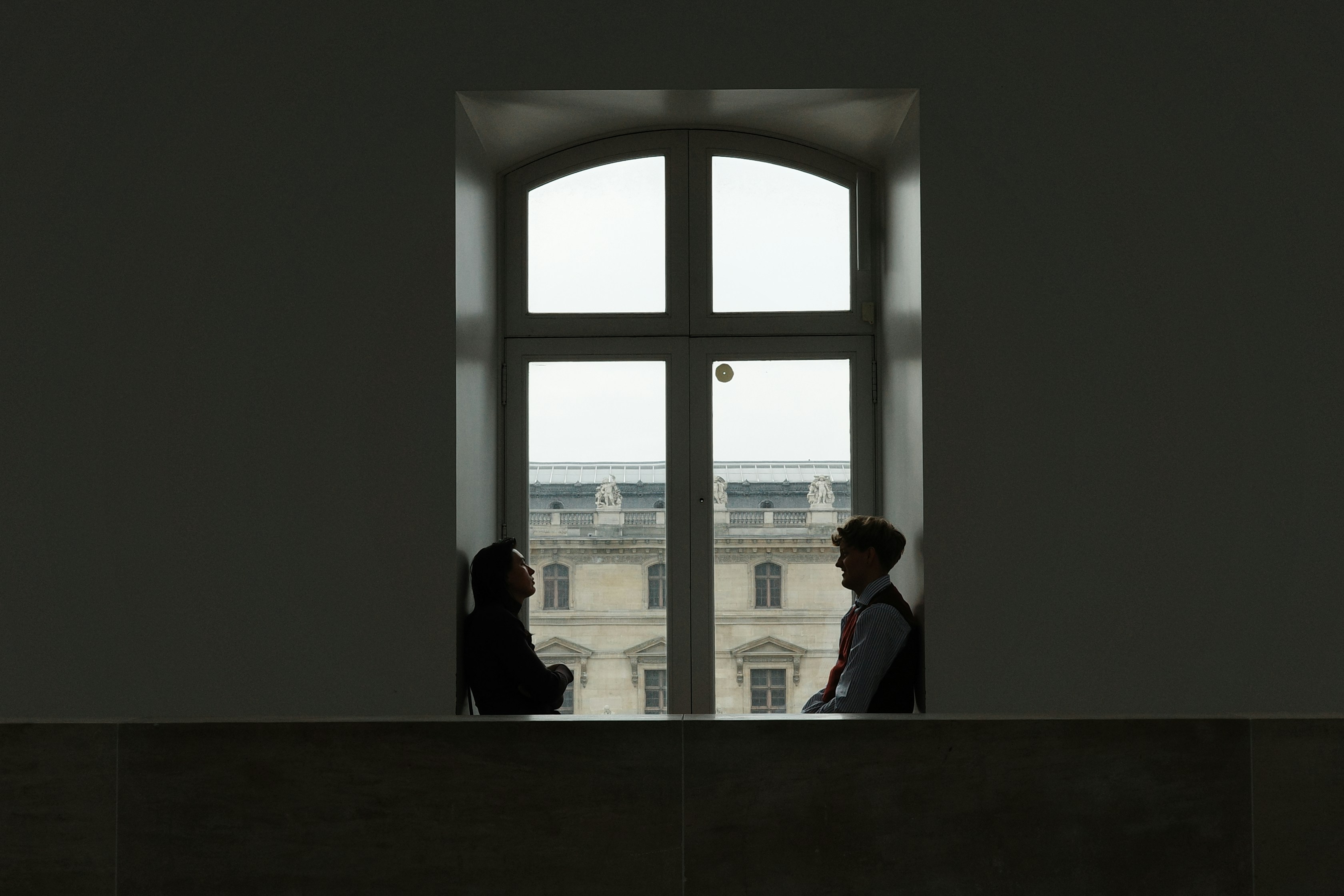 Silhouettes in Conversation by the Window