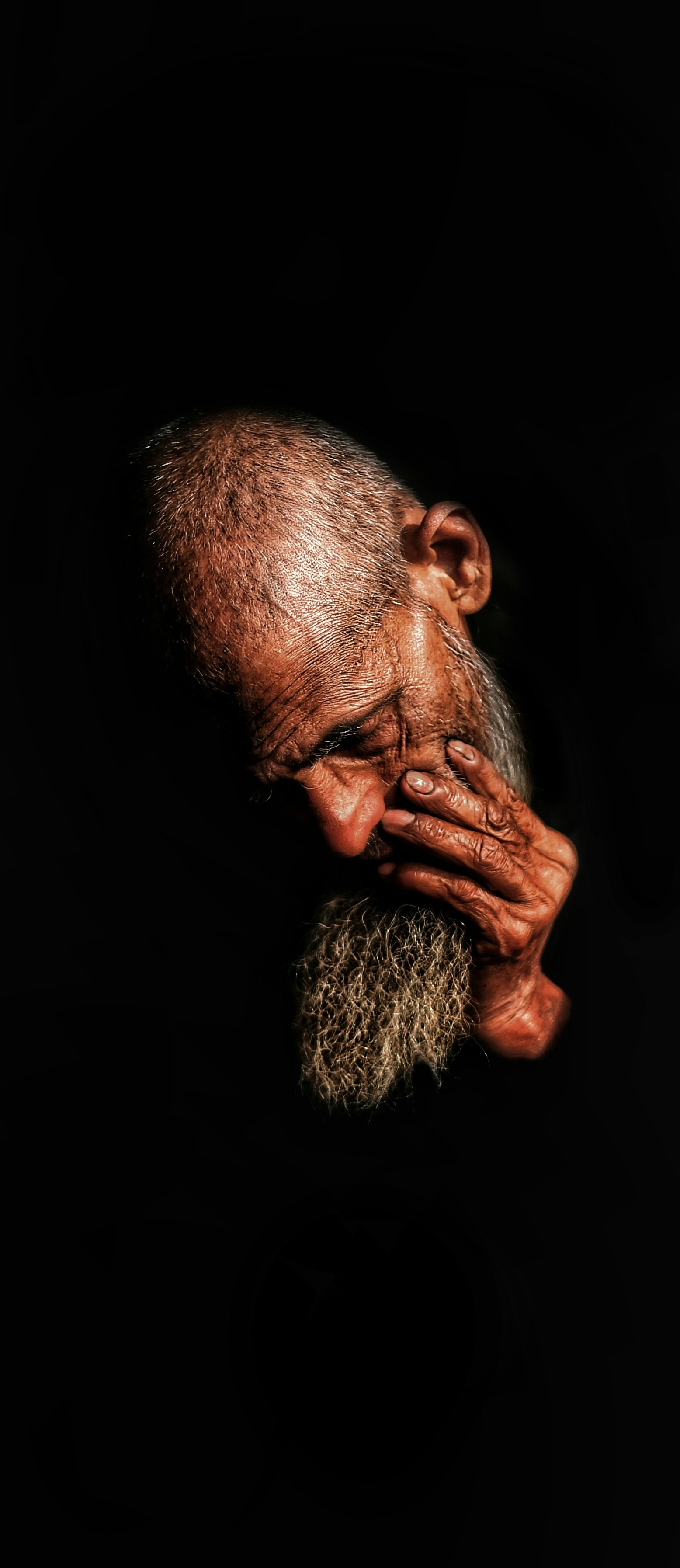 Quiet Burden in Sidelight: Portrait of a Weathered Elder
