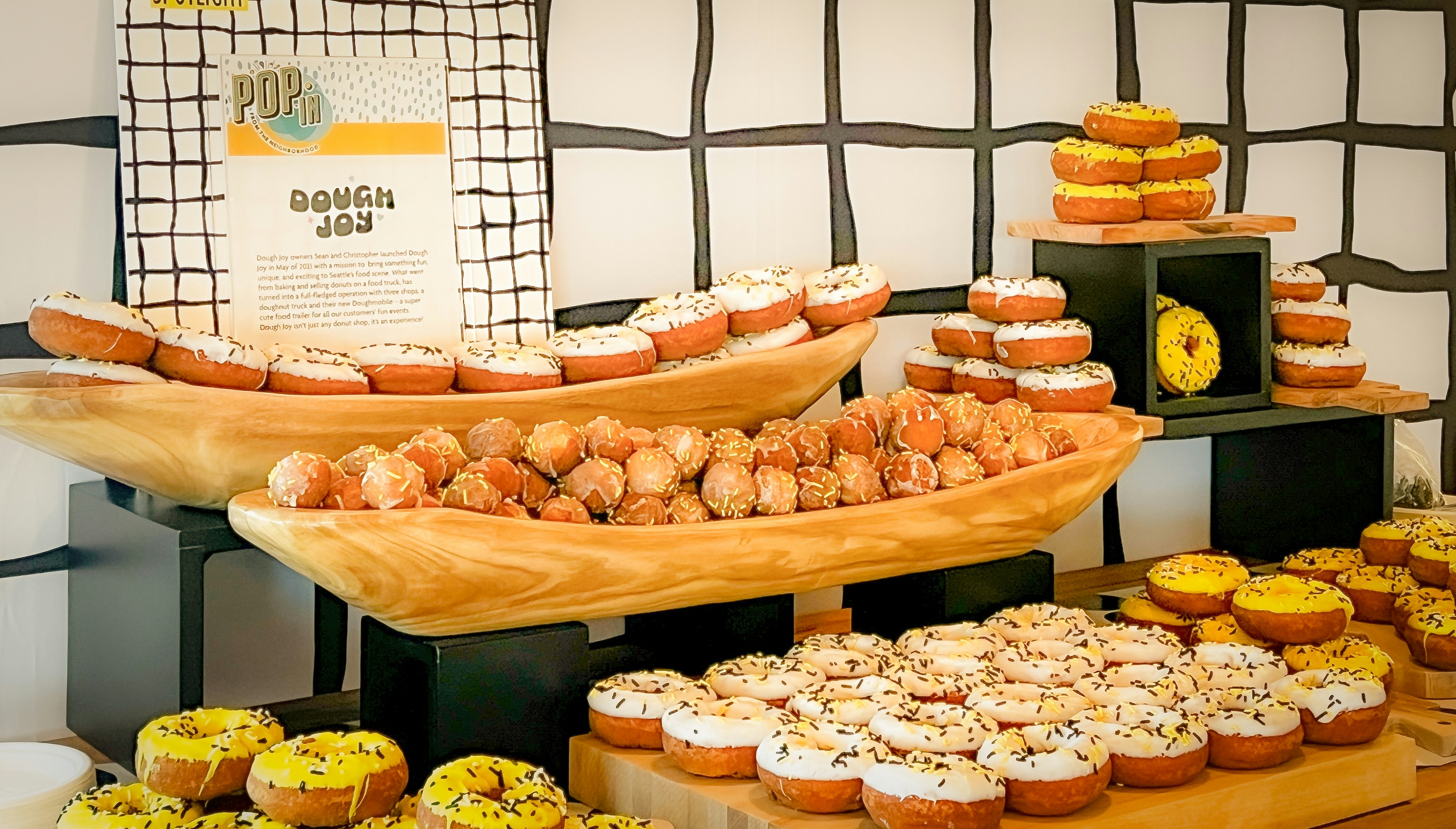 Carousel of Golden Donuts: A Bakery Display in Warm Light