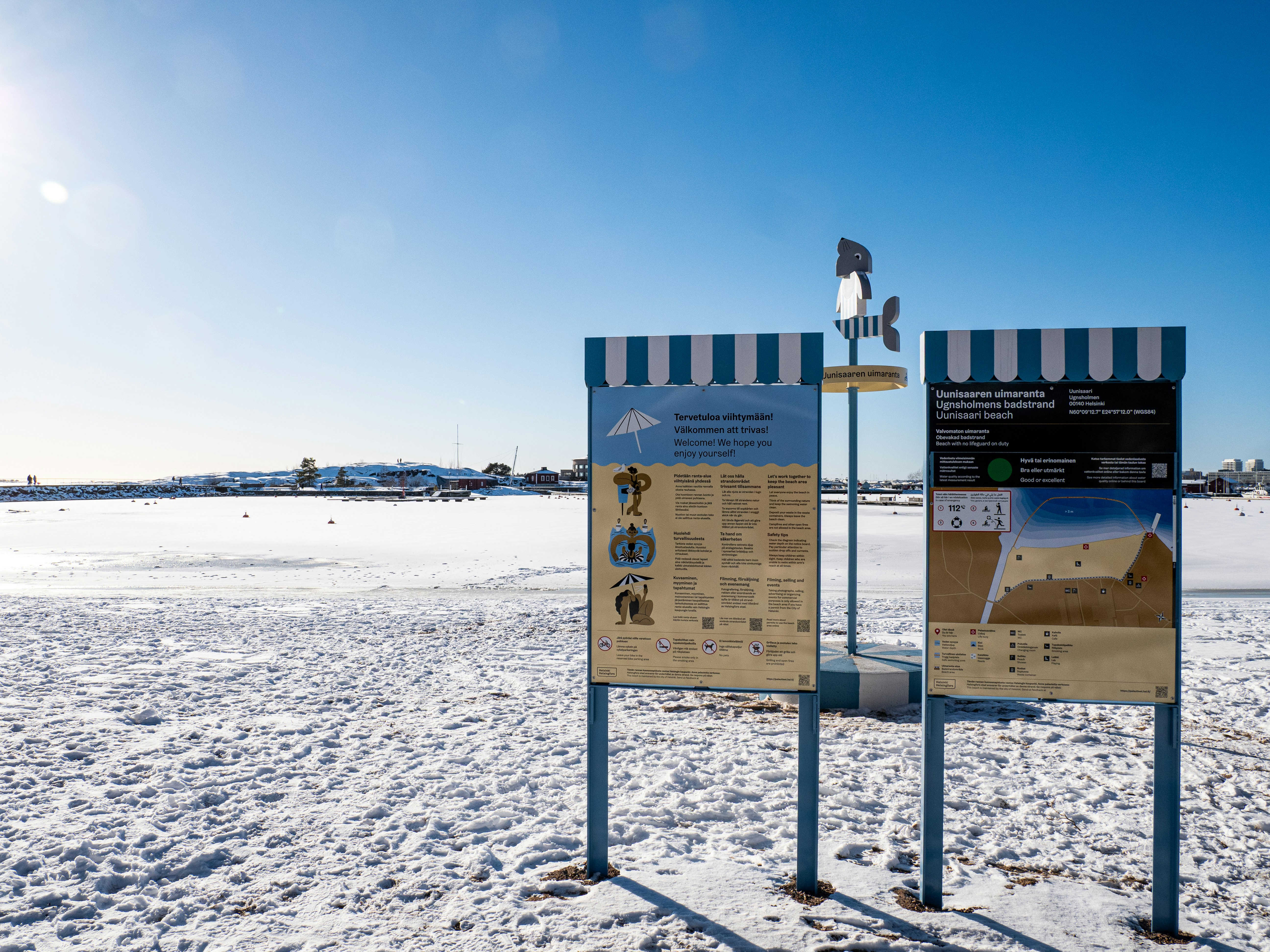 Wind-Swept Beach Information Boards in Bright Winter Light