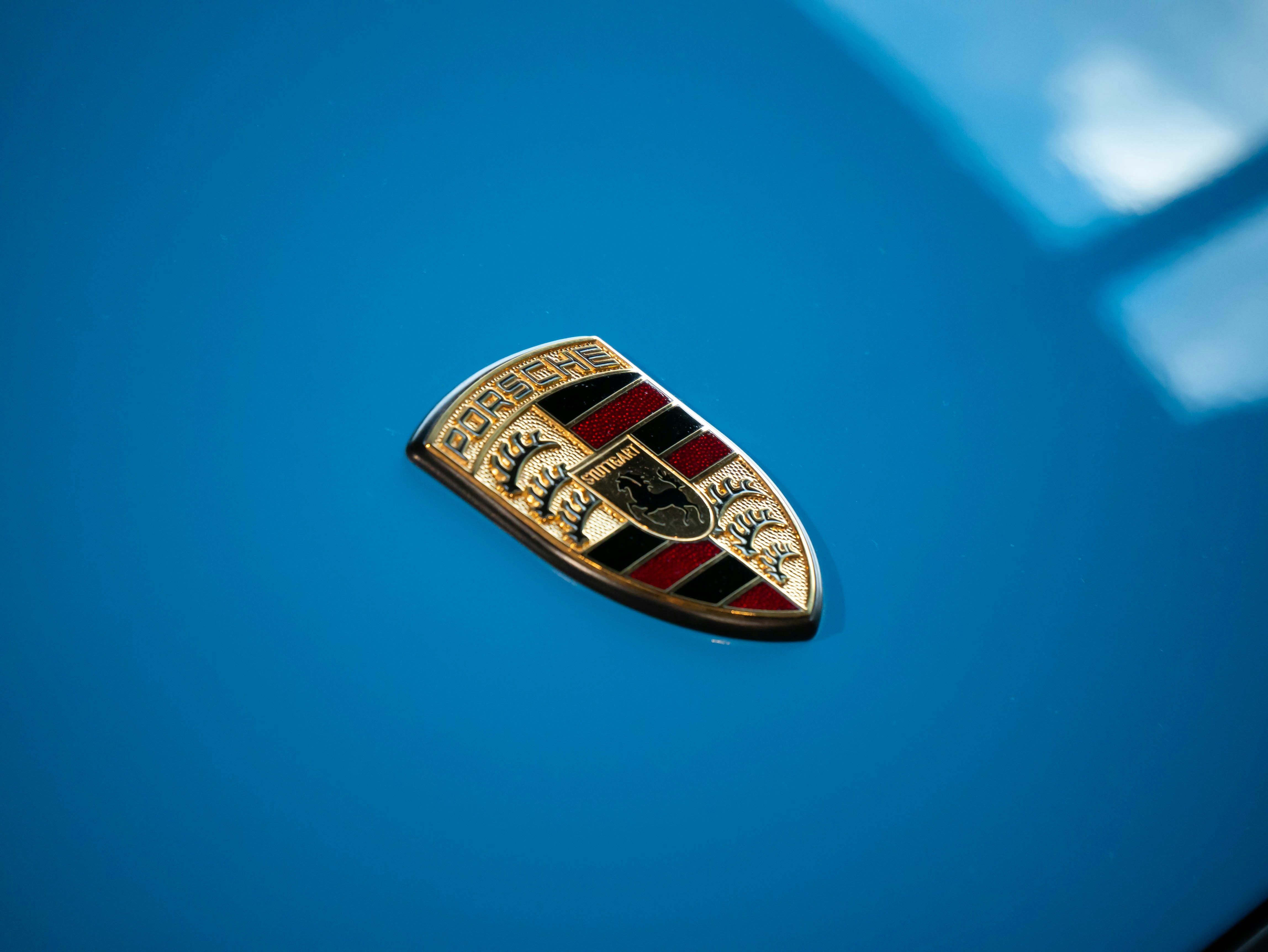 Porsche Crest Closeup on a Brilliant Blue Hood
