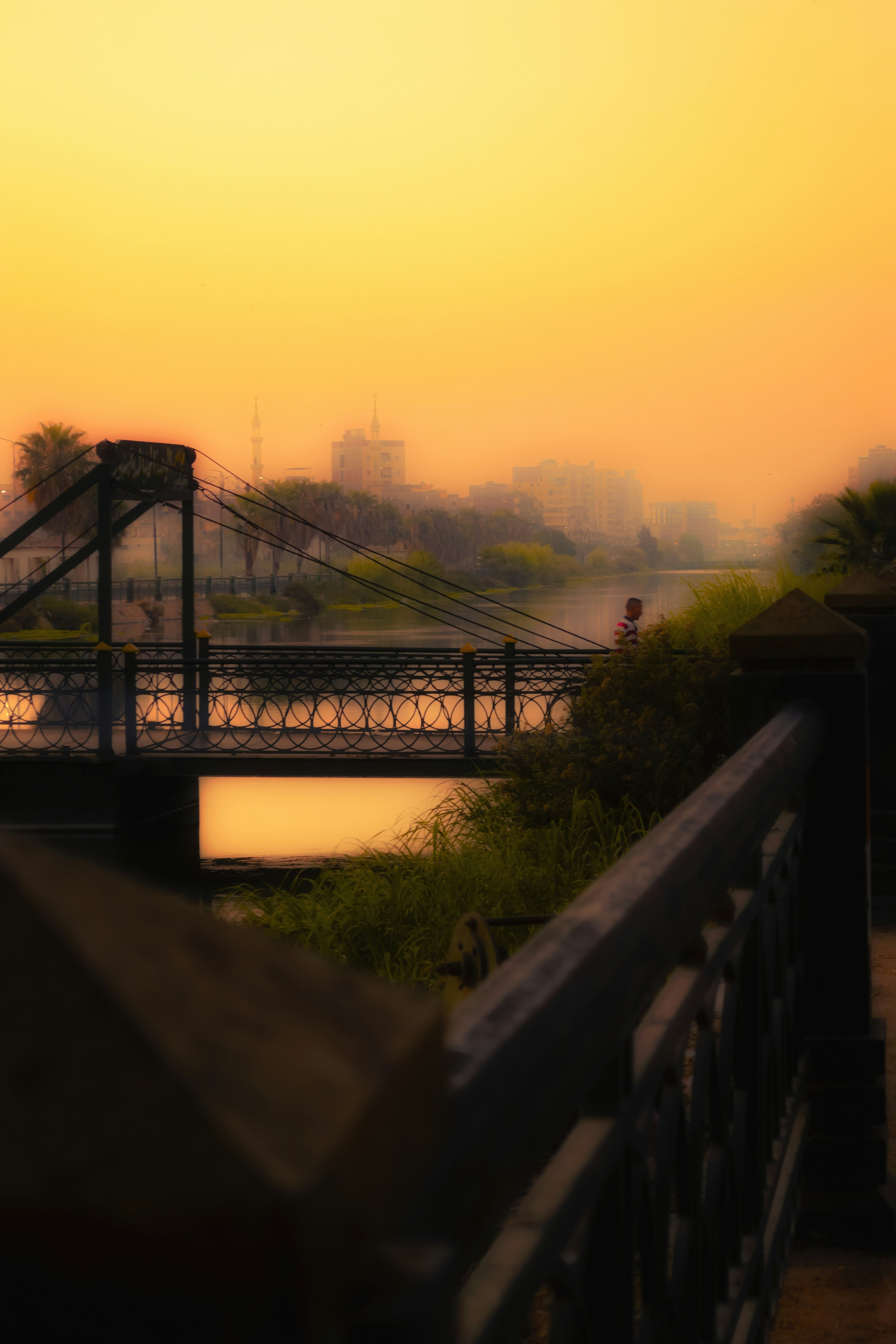 Golden Hour Overlook: A Quiet Riverwalk Silhouette