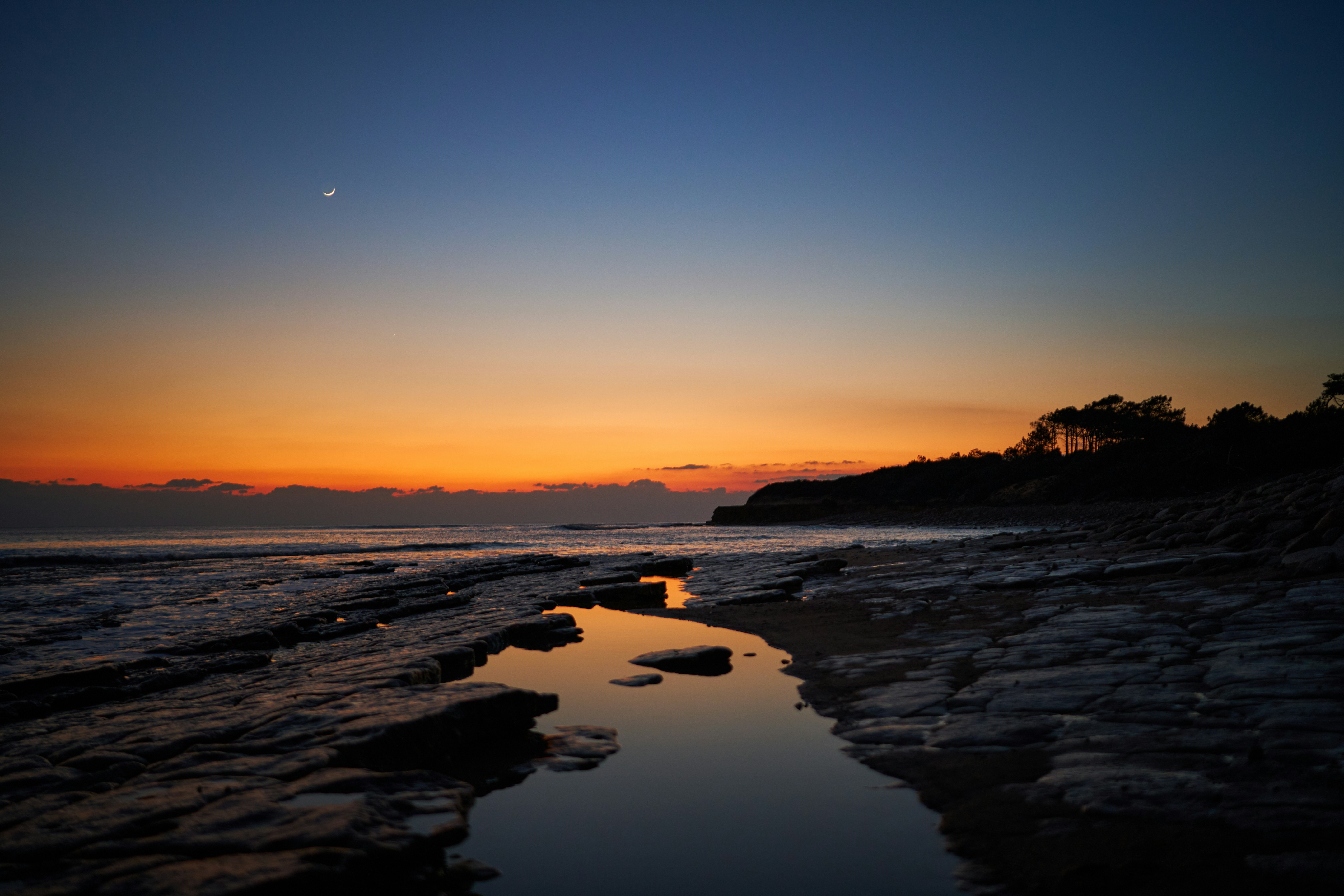 Twilight Reflections on the Rocky Shore