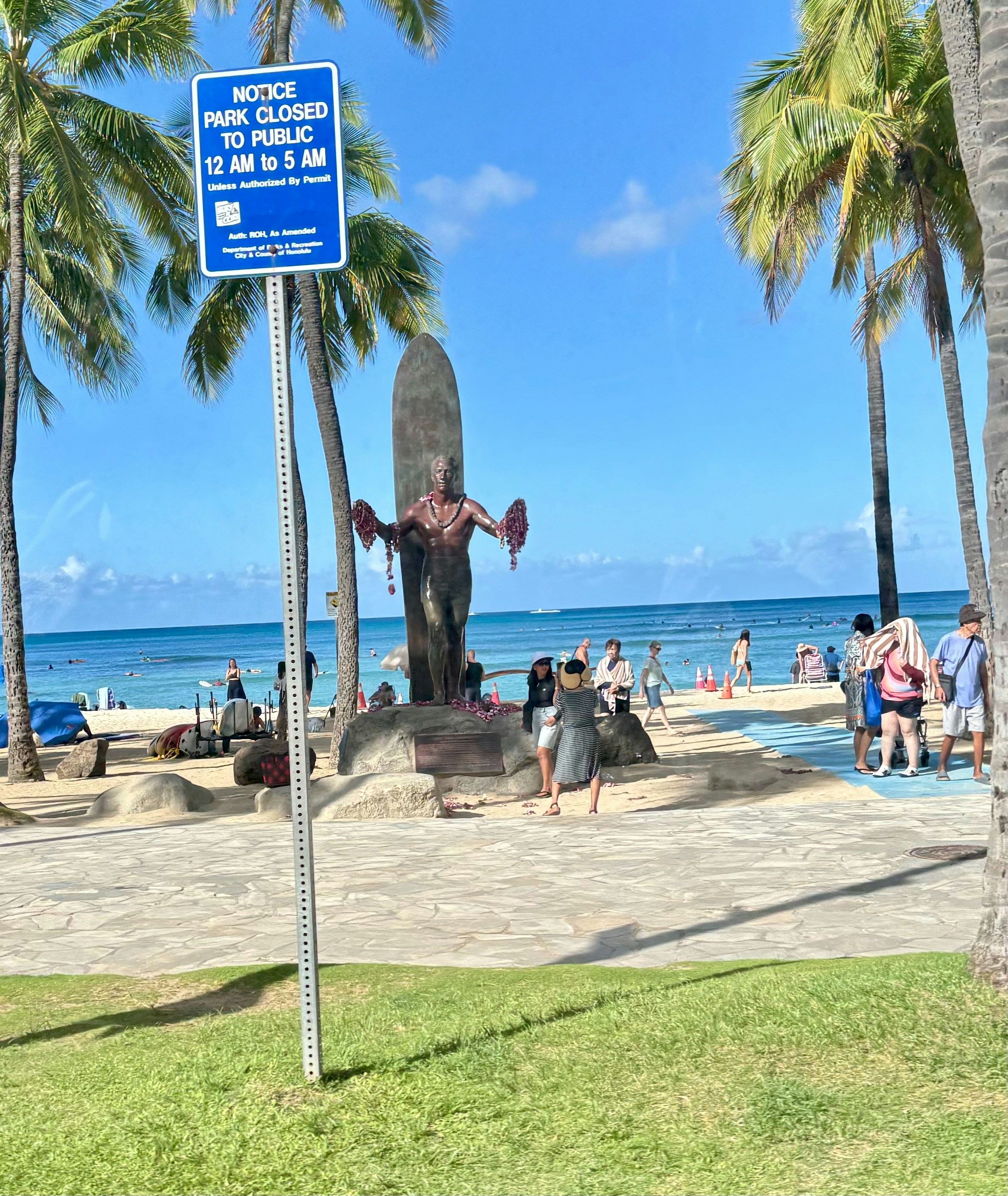 Surfside Sentinel: A Bustling Beachfront Scene with a Monument and Palms