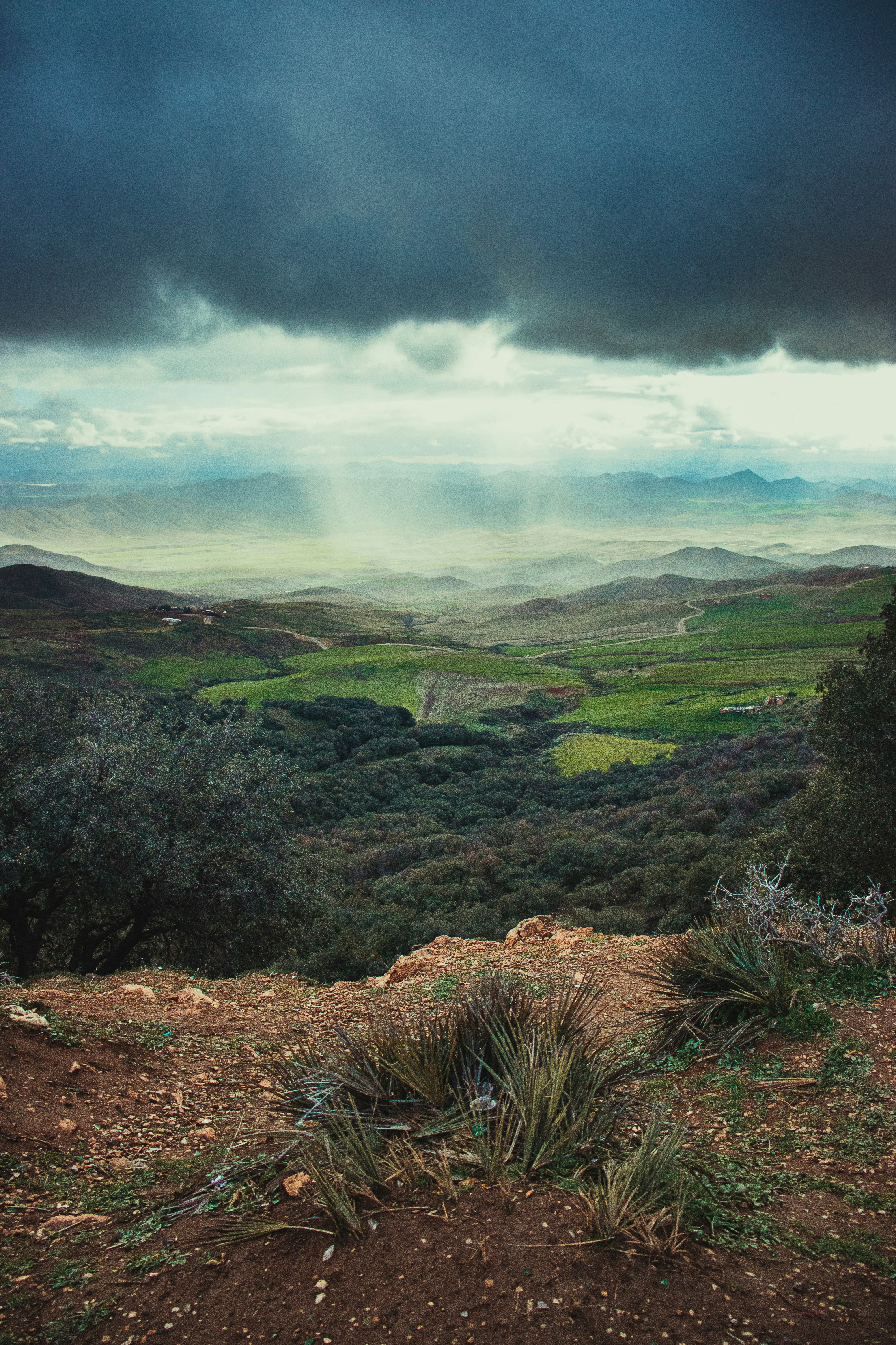 Dramatic Valley Rainfall Pierces a Quiet Horizon