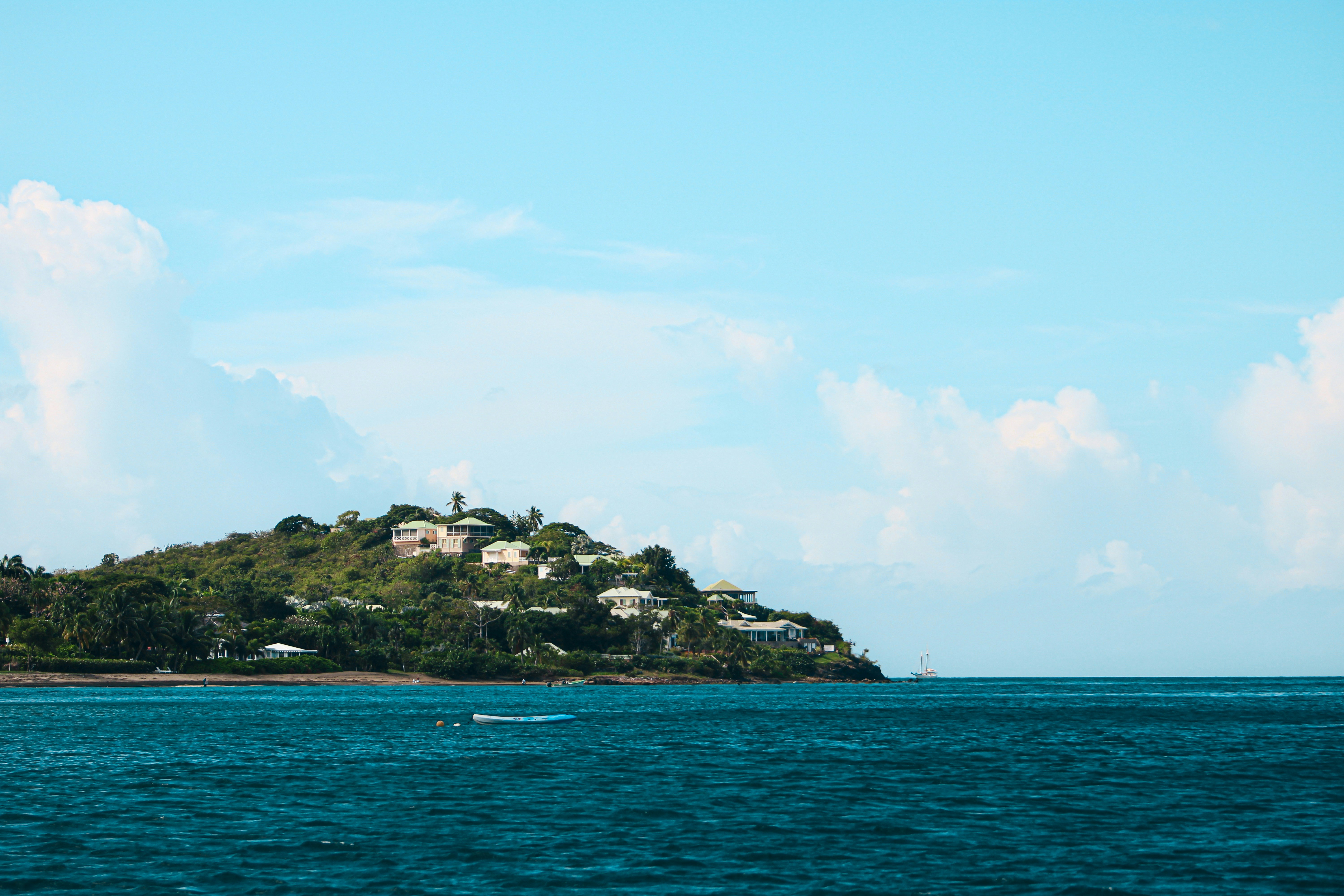 A tropical island overlooks the azure ocean. photo – Free Boat Image on ...