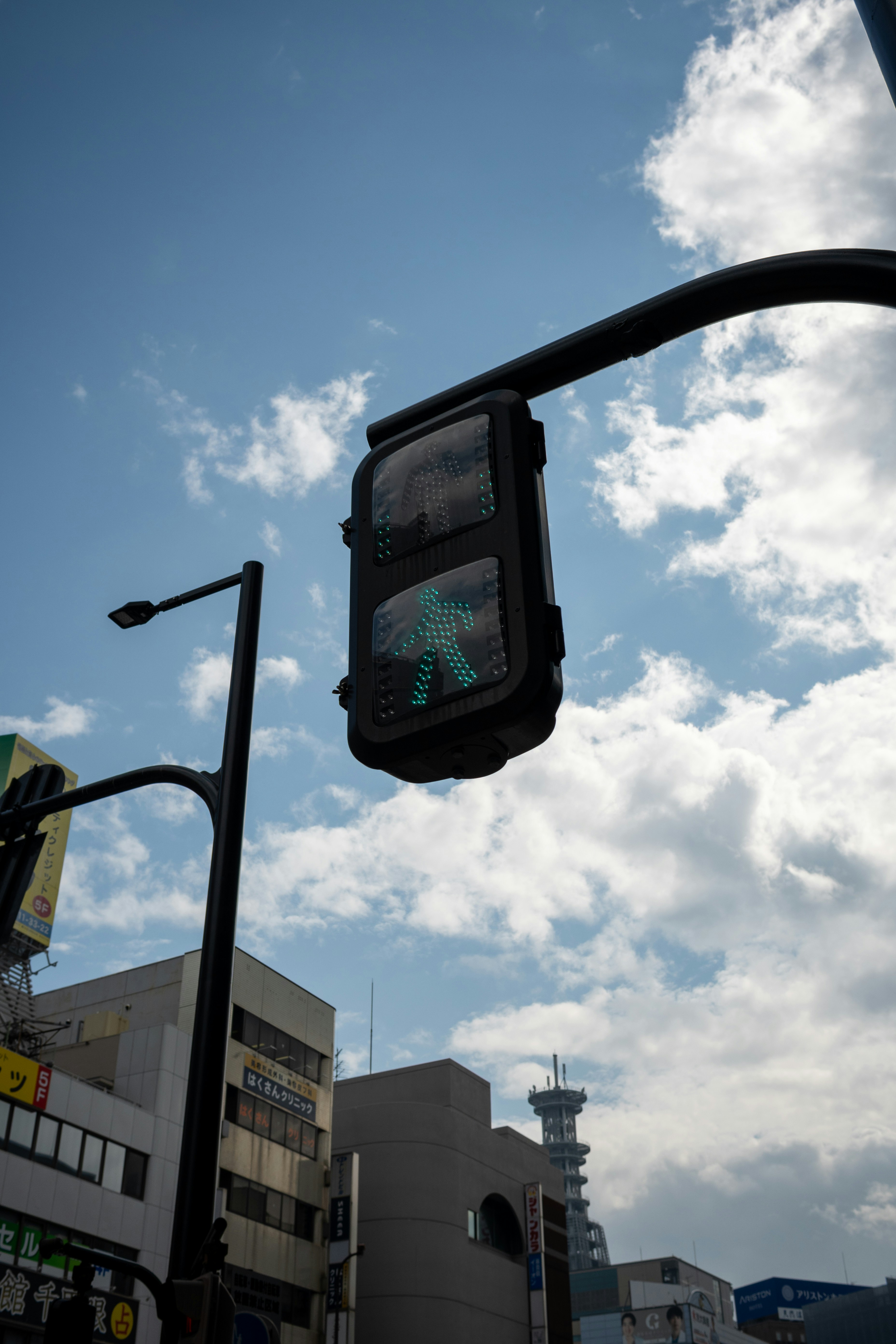 A traffic light on a city street with buildings in the background photo ...