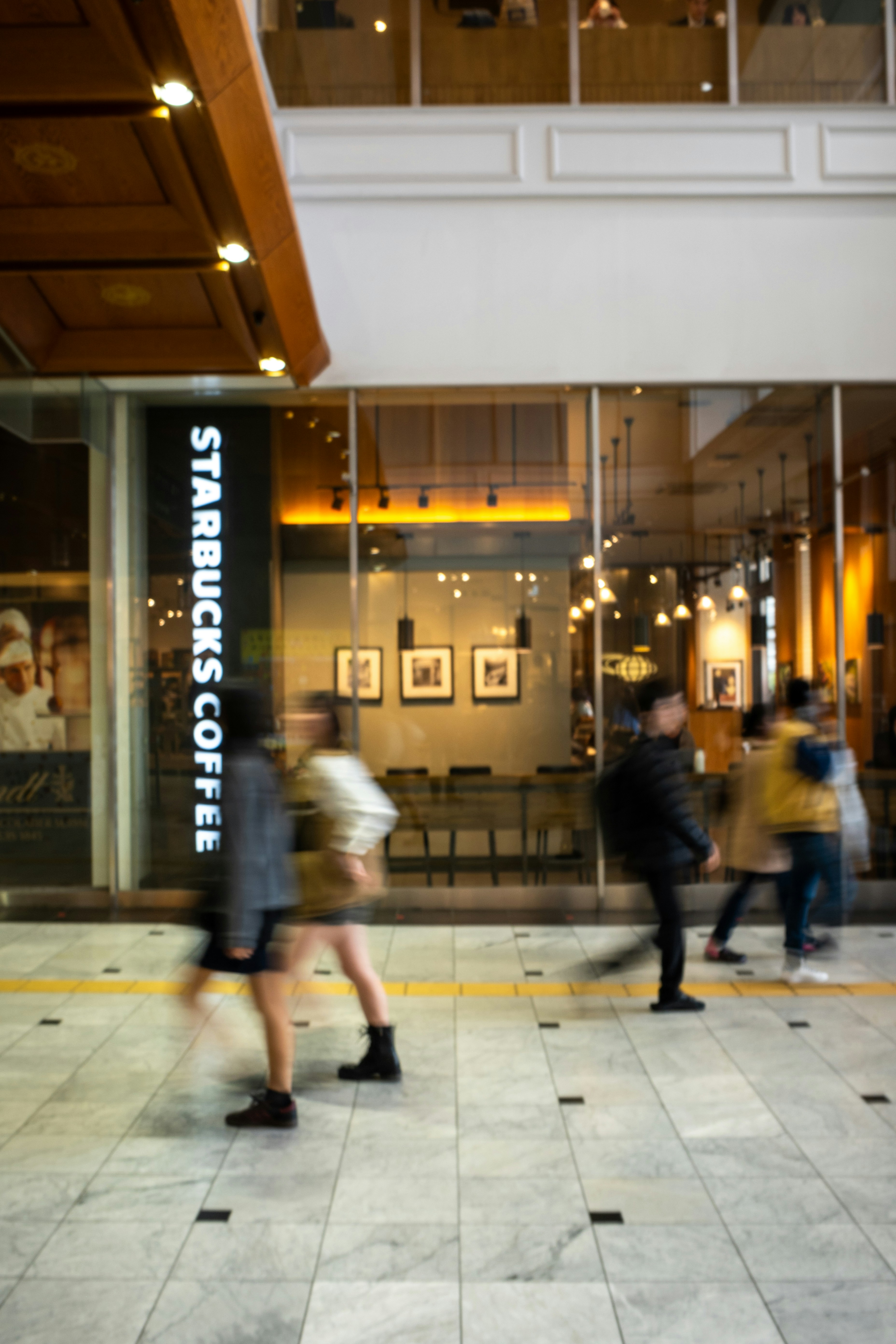 A group of people walking in front of a store photo – Free Woman Image ...
