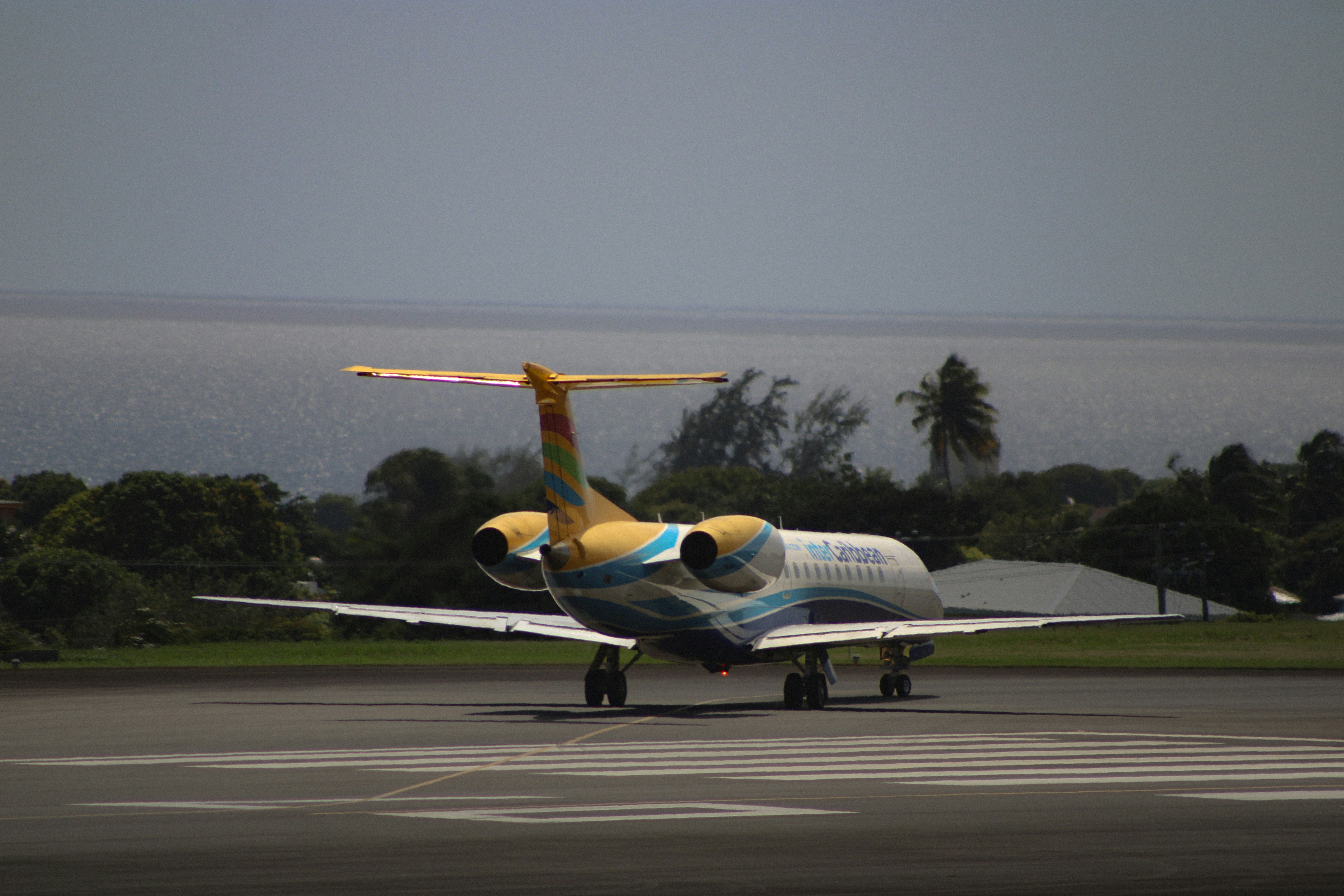 Coastal Runway: Turquoise-tail Regional Jet on a Quiet Taxi