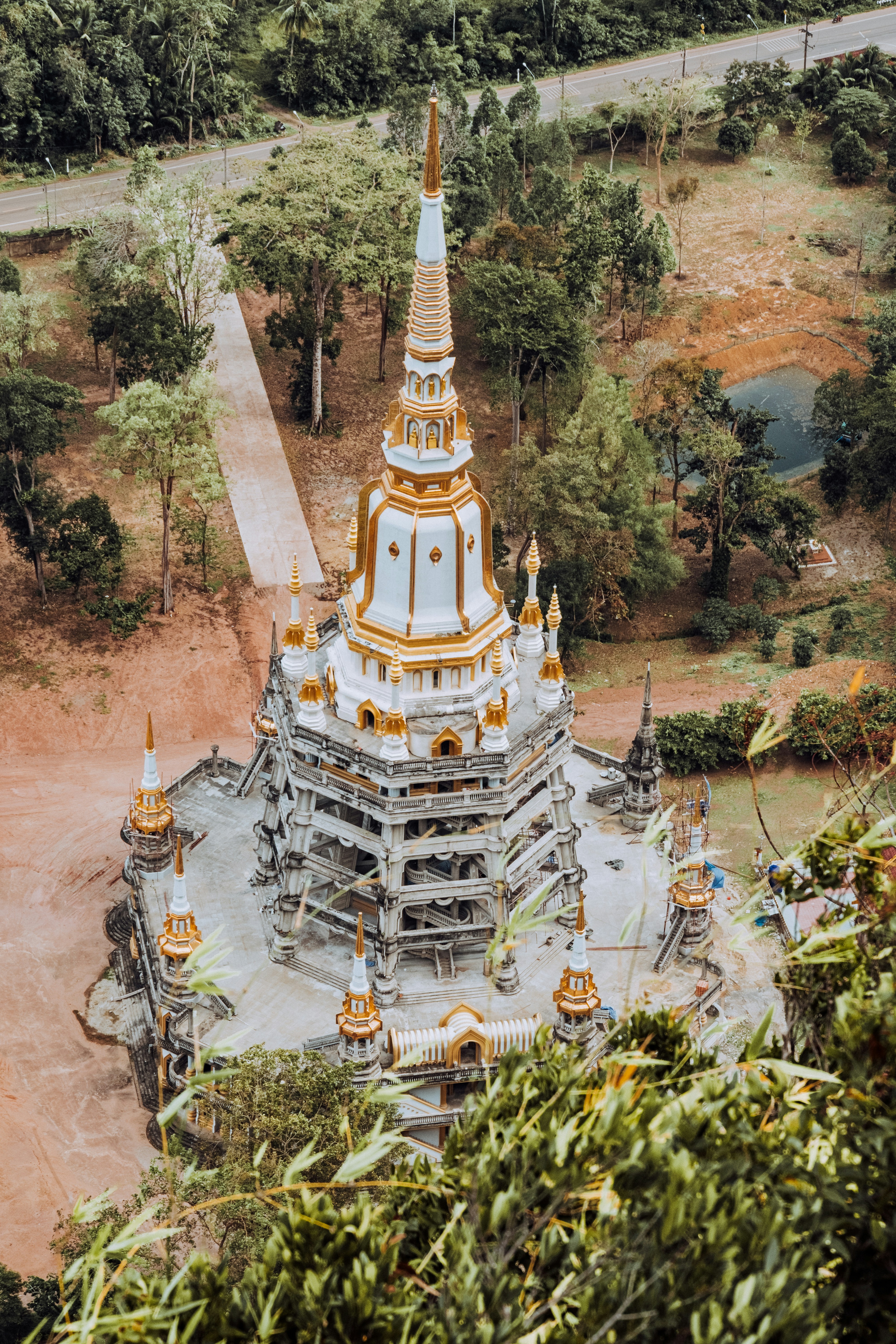 Gold Spire Above Green Canopy: An Aerial Portrait of a Southeast Asian Temple