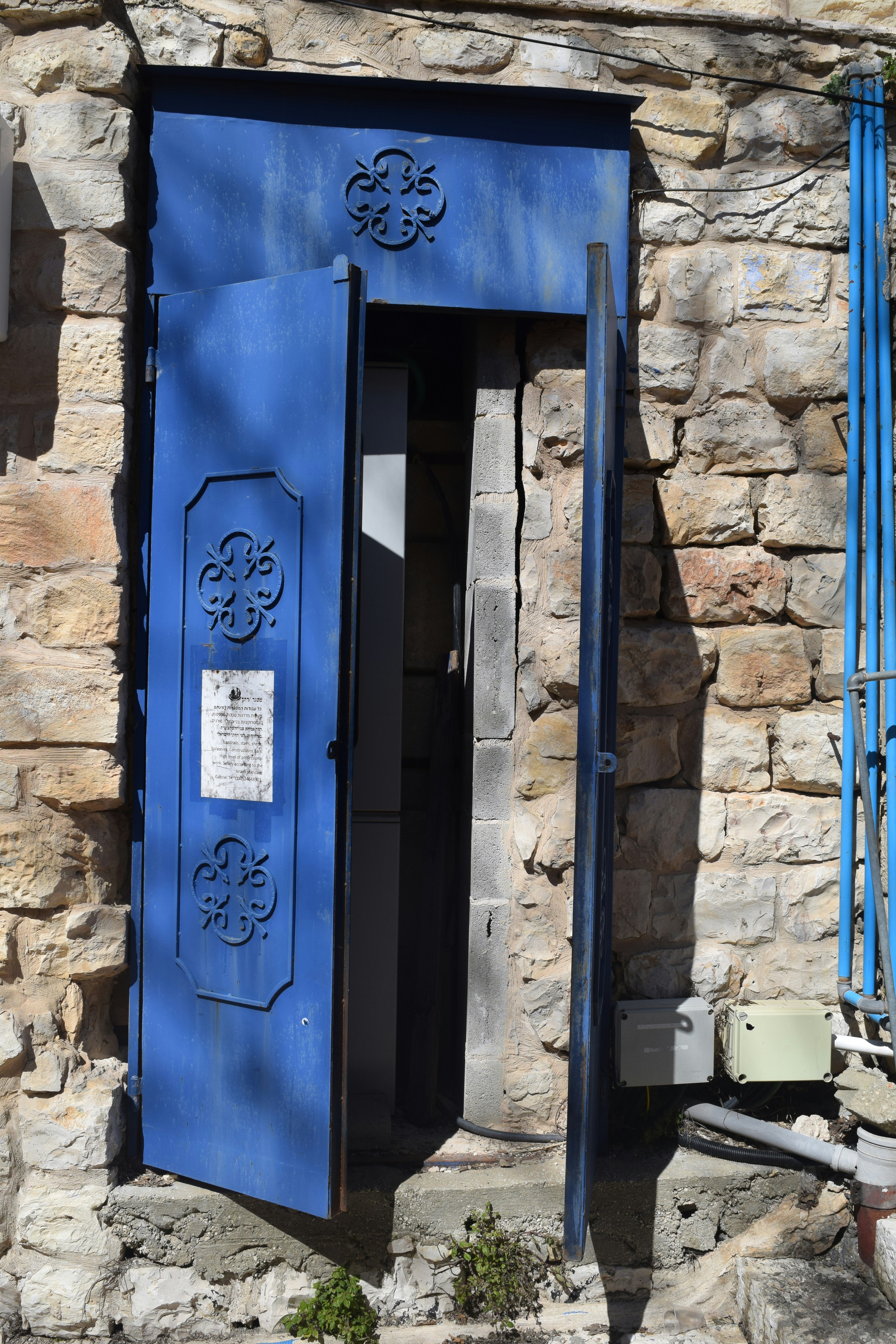 Azure Doorway: A Weathered Portal in a Stone Facade
