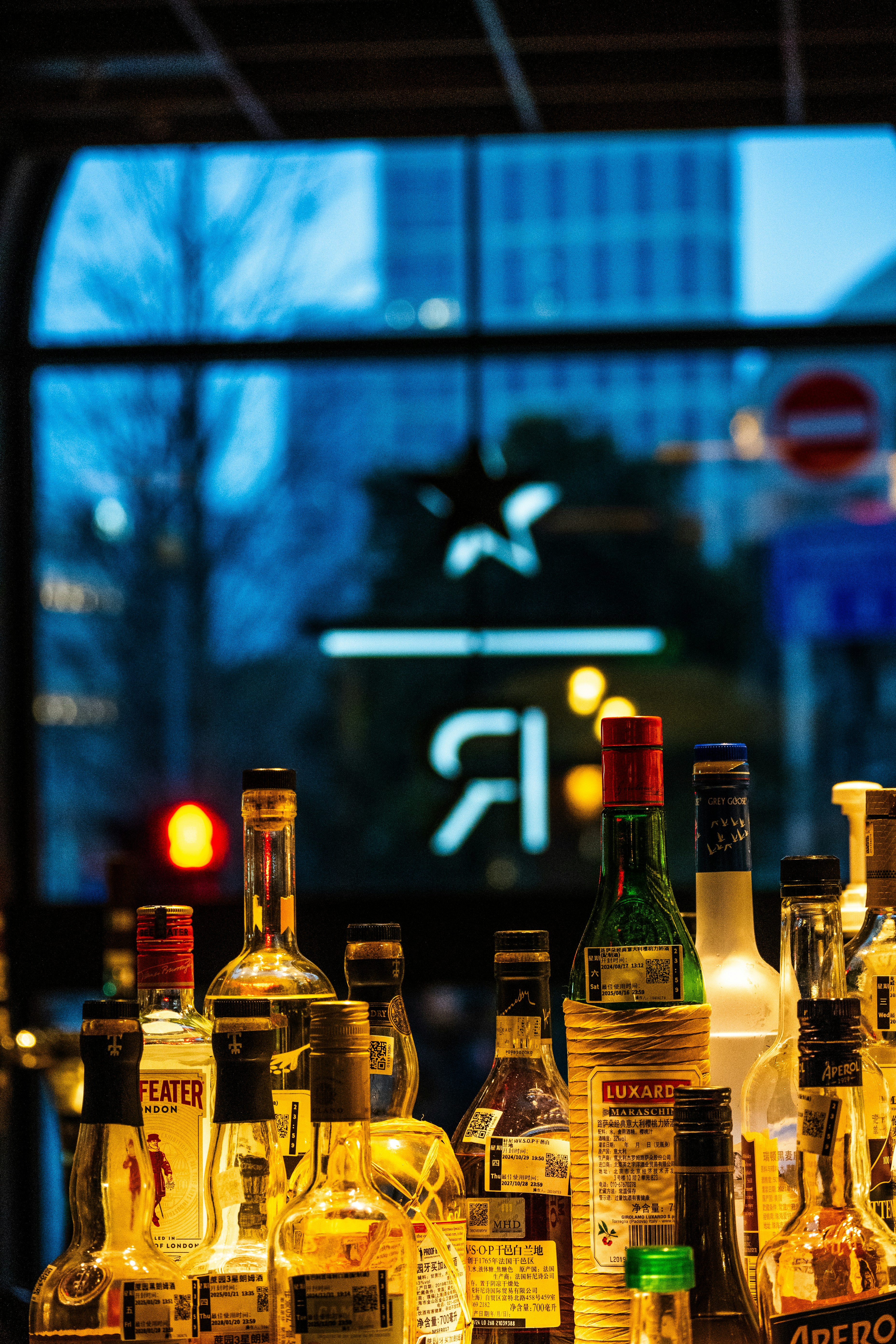 Amber Bottles under a Blue Window: Quiet Urban Bar Portrait