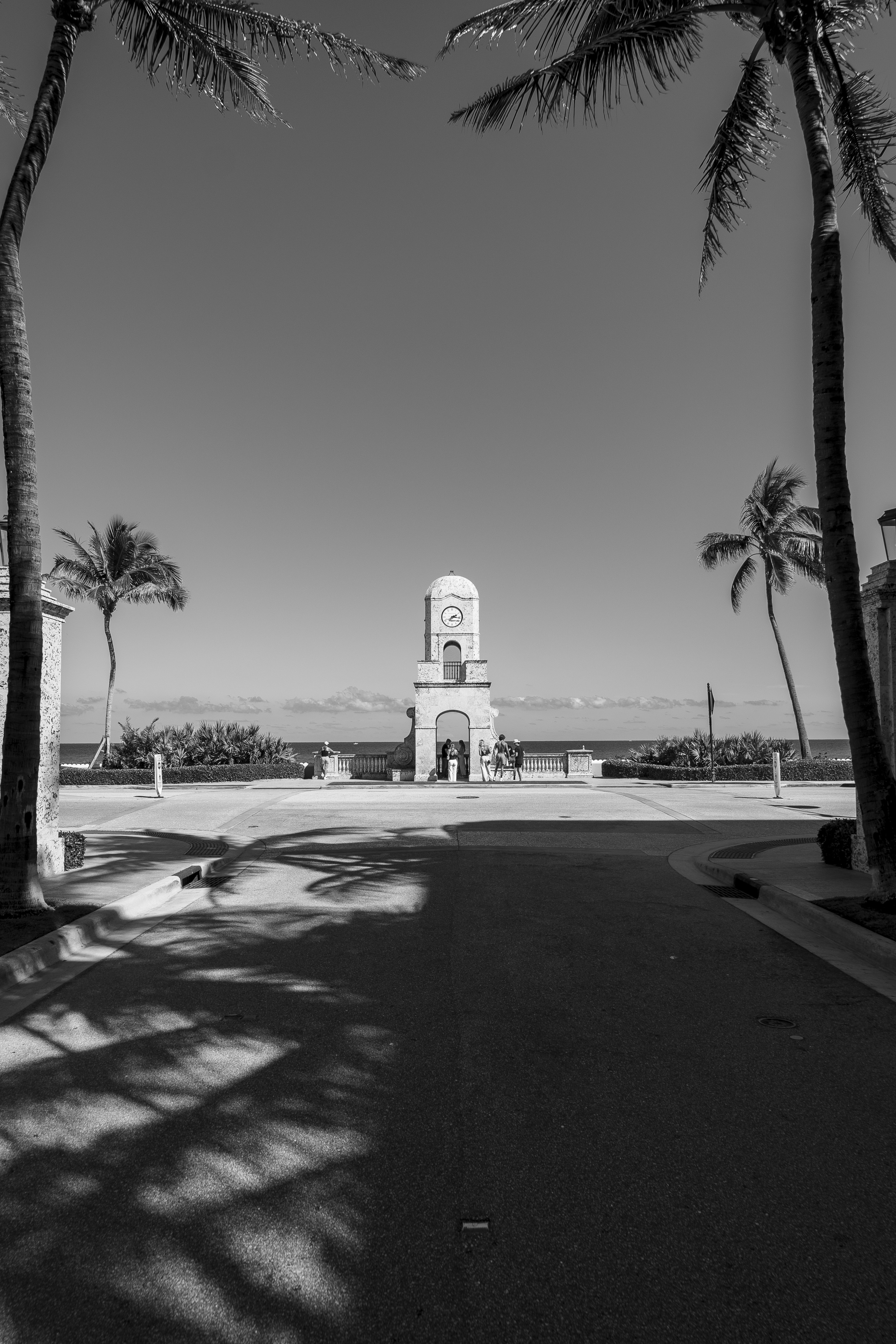 Coastal Clock Tower: Palm-Framed Route to the Sea