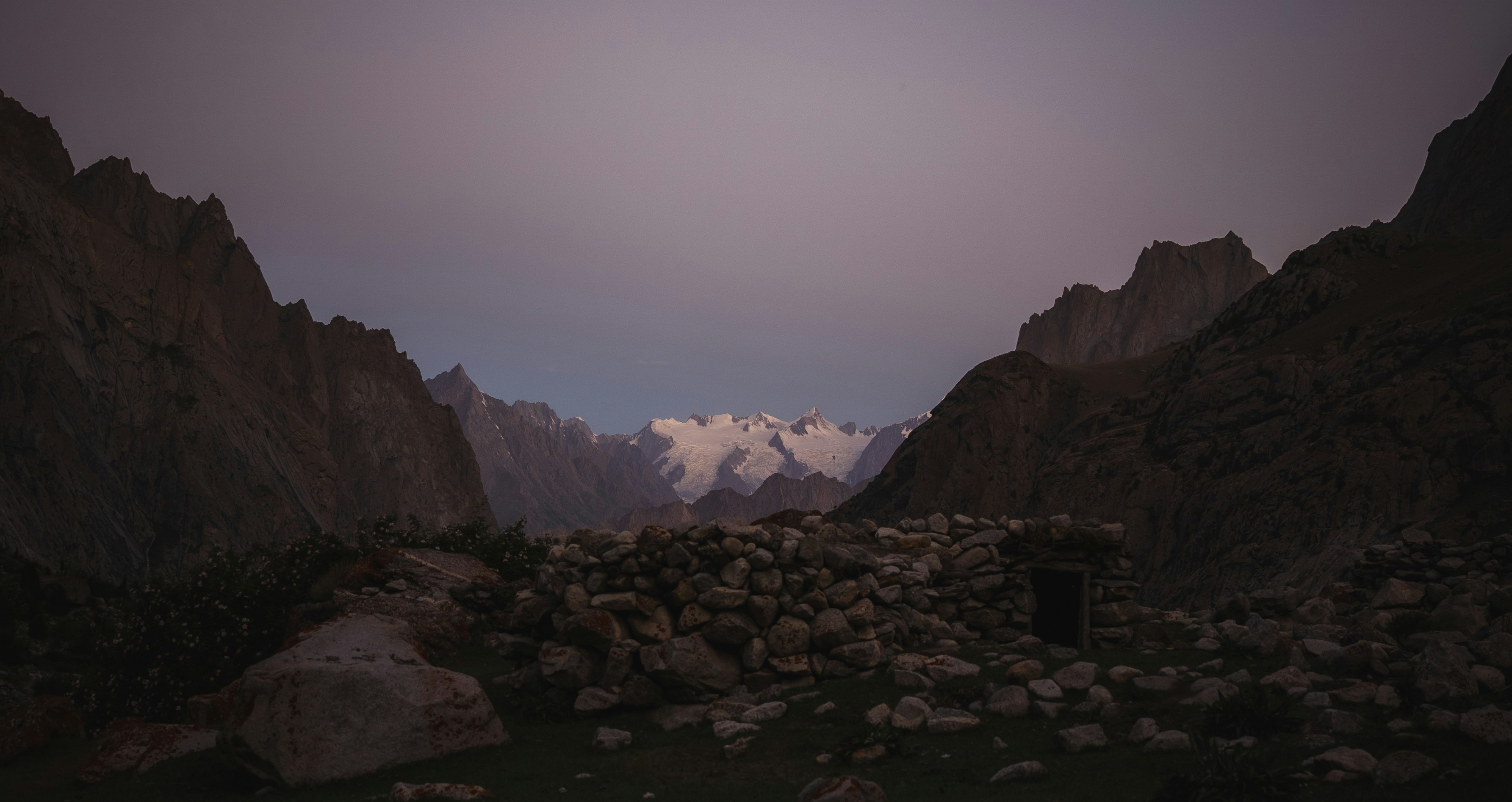Dawn in the Cirques: Snow-capped Peak Framed by Jagged Valleys