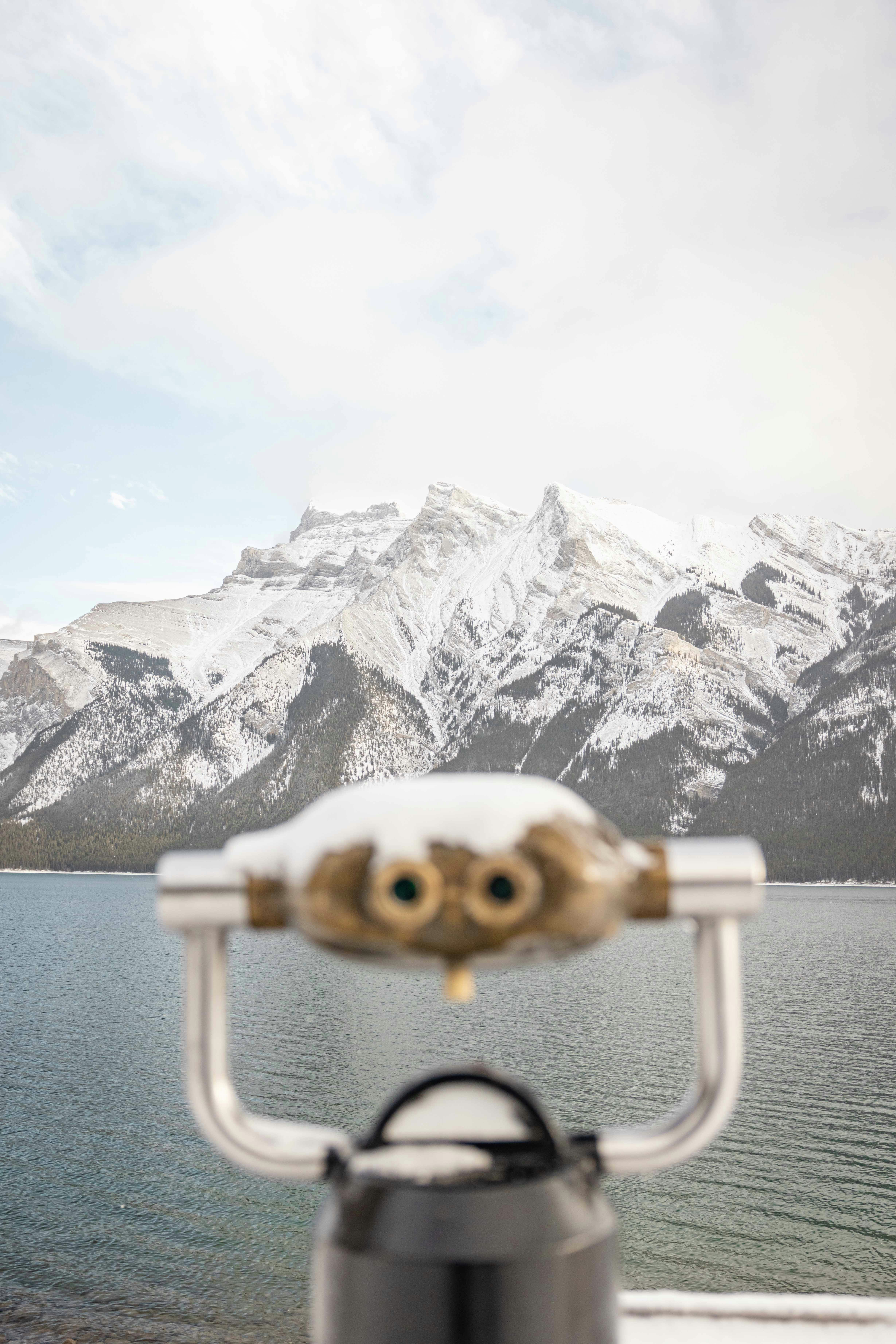 Gaze Across the Lake: Snowy Peaks Framed by a Foreground Viewer