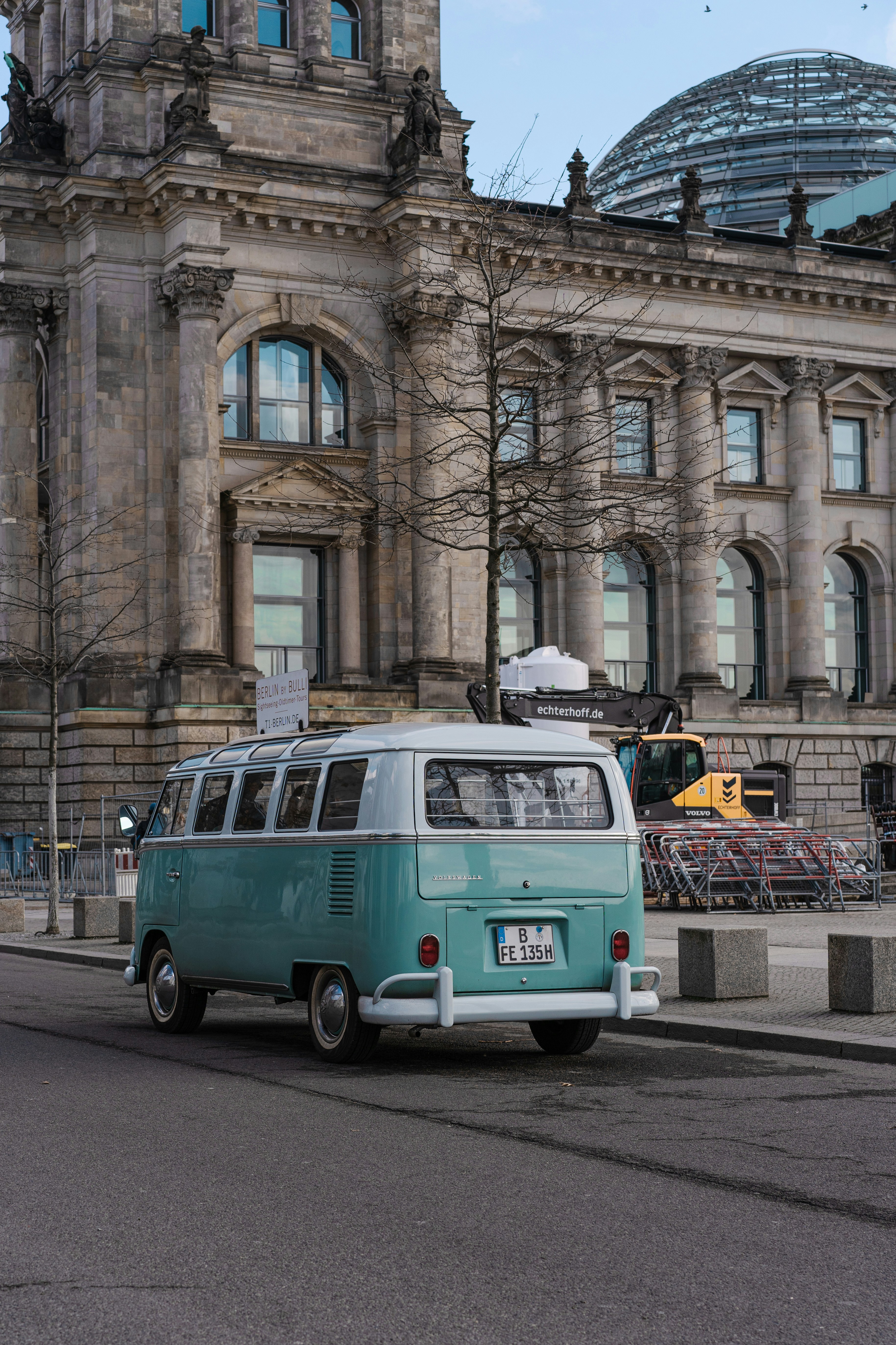 Teal VW Bus Stands Before a Beaux-Arts Facade