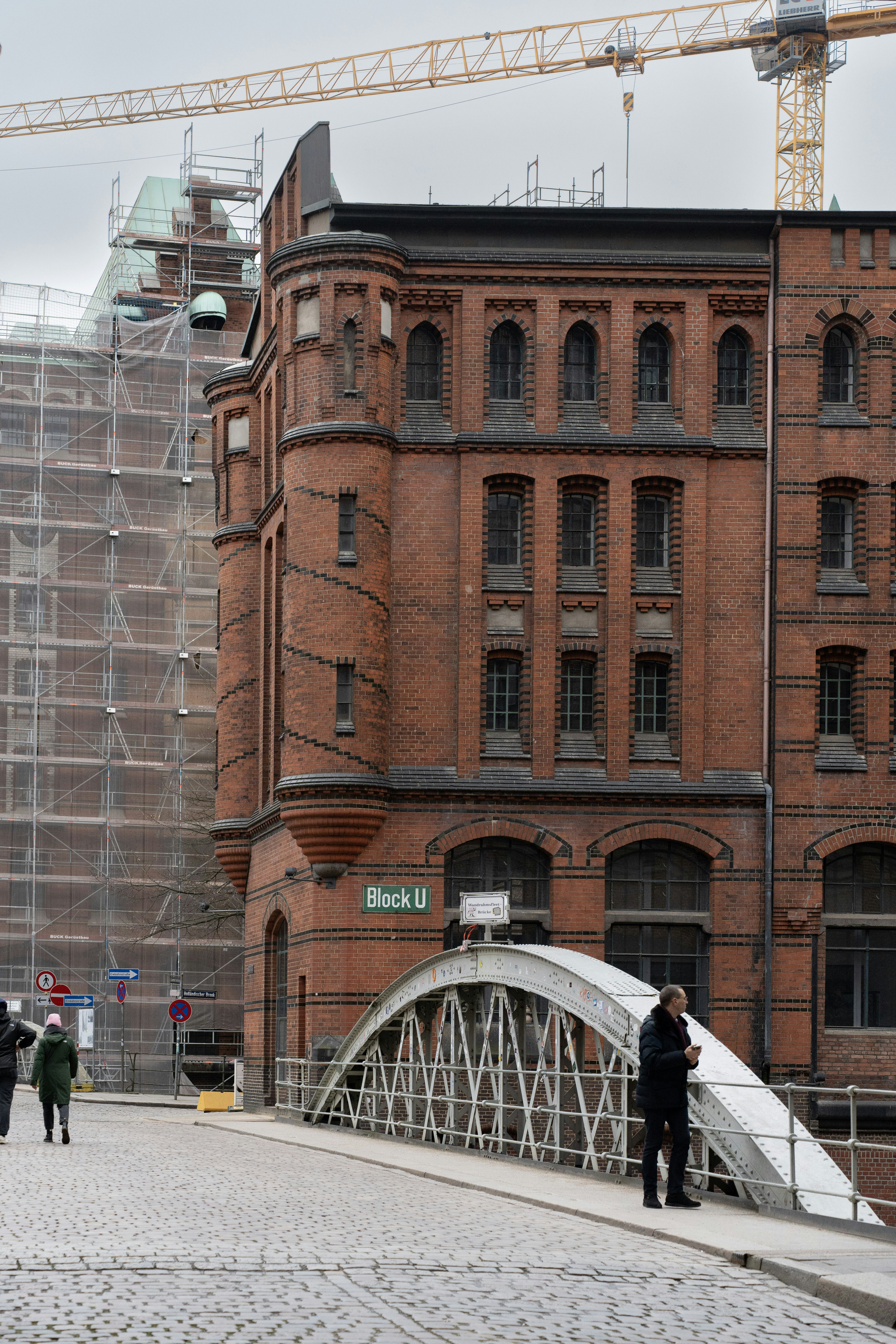 A group of people walking across a bridge photo – Free Architecture ...