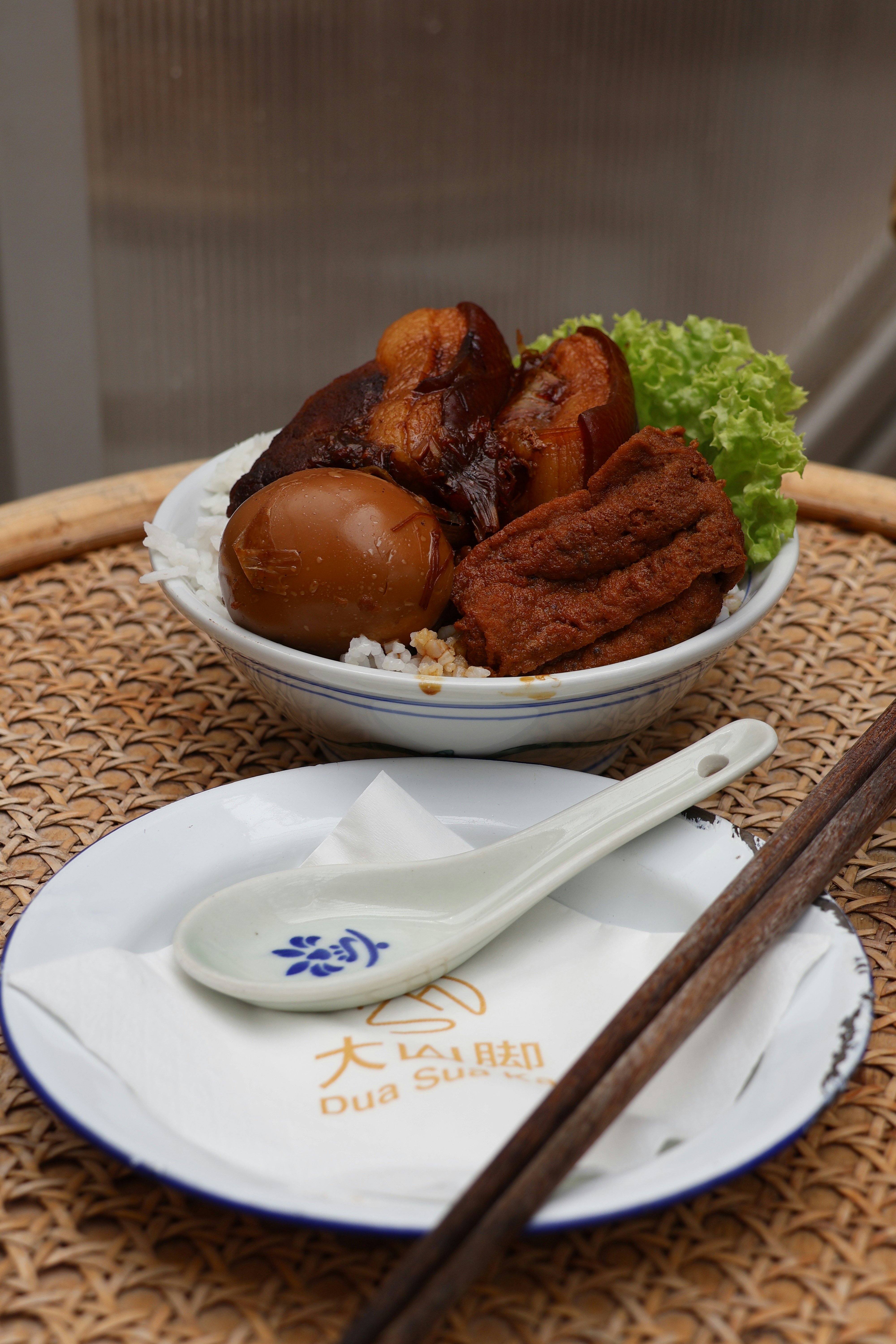 Sticky Braised Pork Belly with Soy Egg Over Rice in a Cozy Bowl
