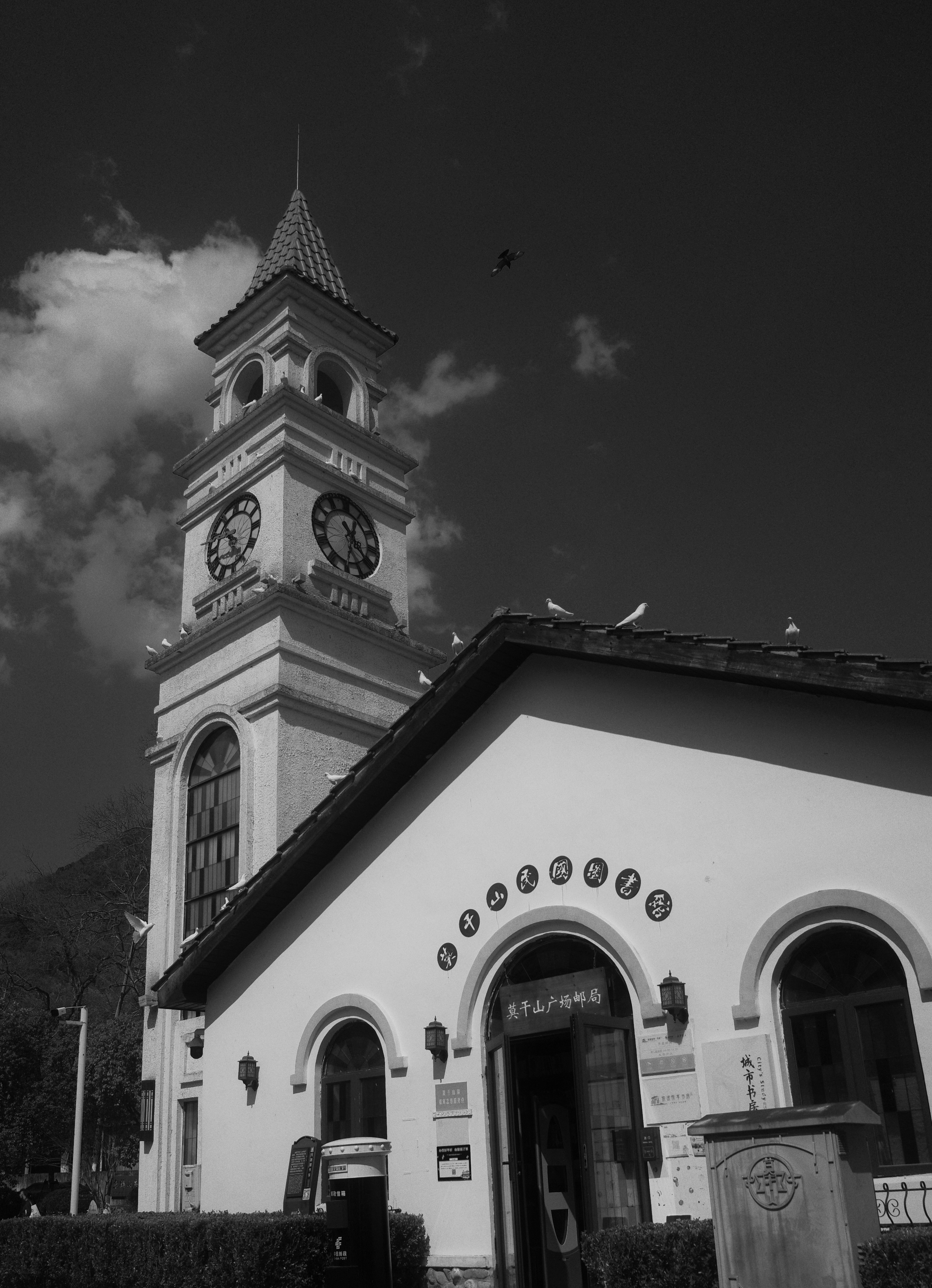Monochrome Clocktower Over a Quiet Chapel