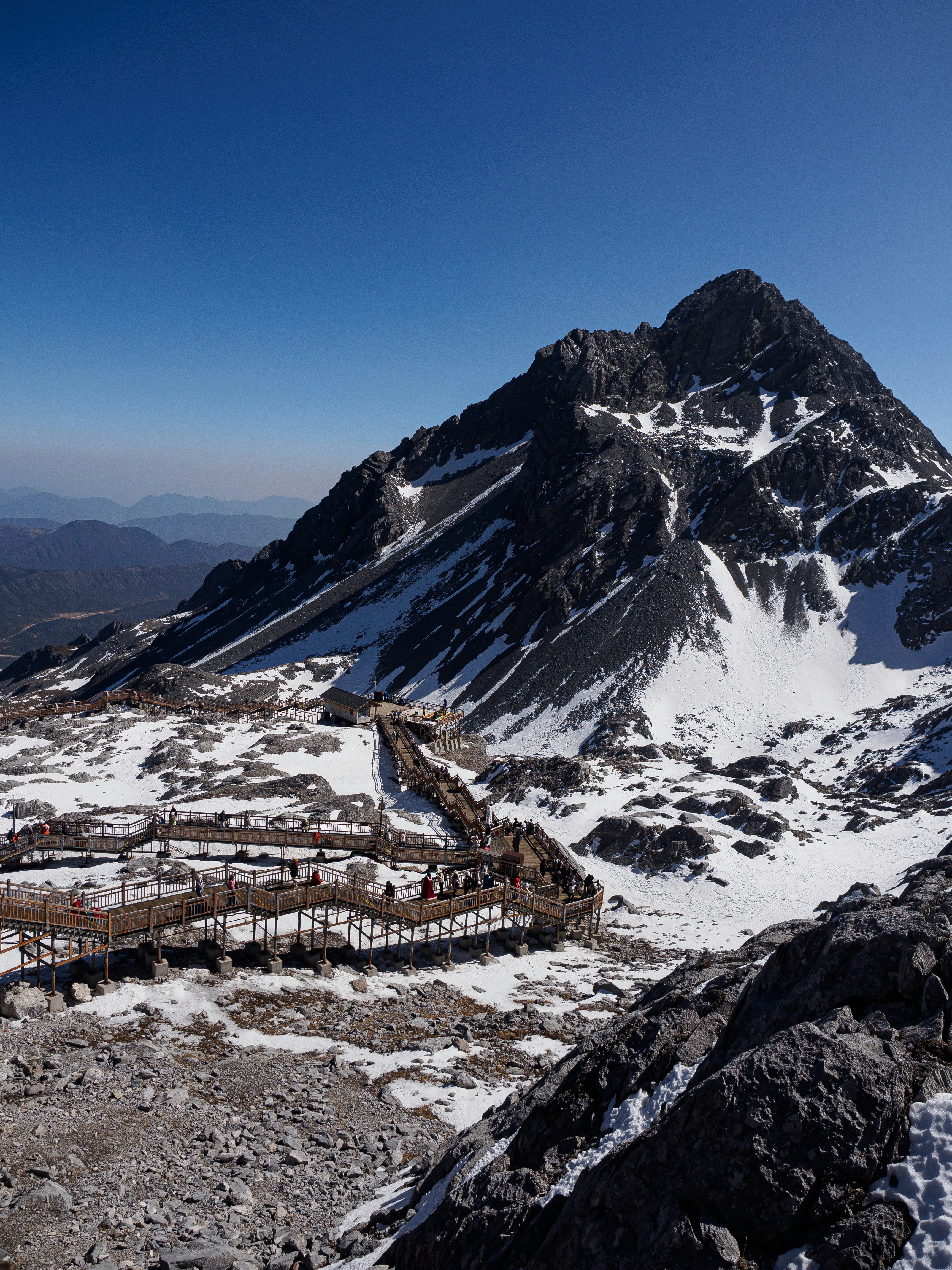 Snowbound Switchbacks Climbing Toward a Sharp Peak