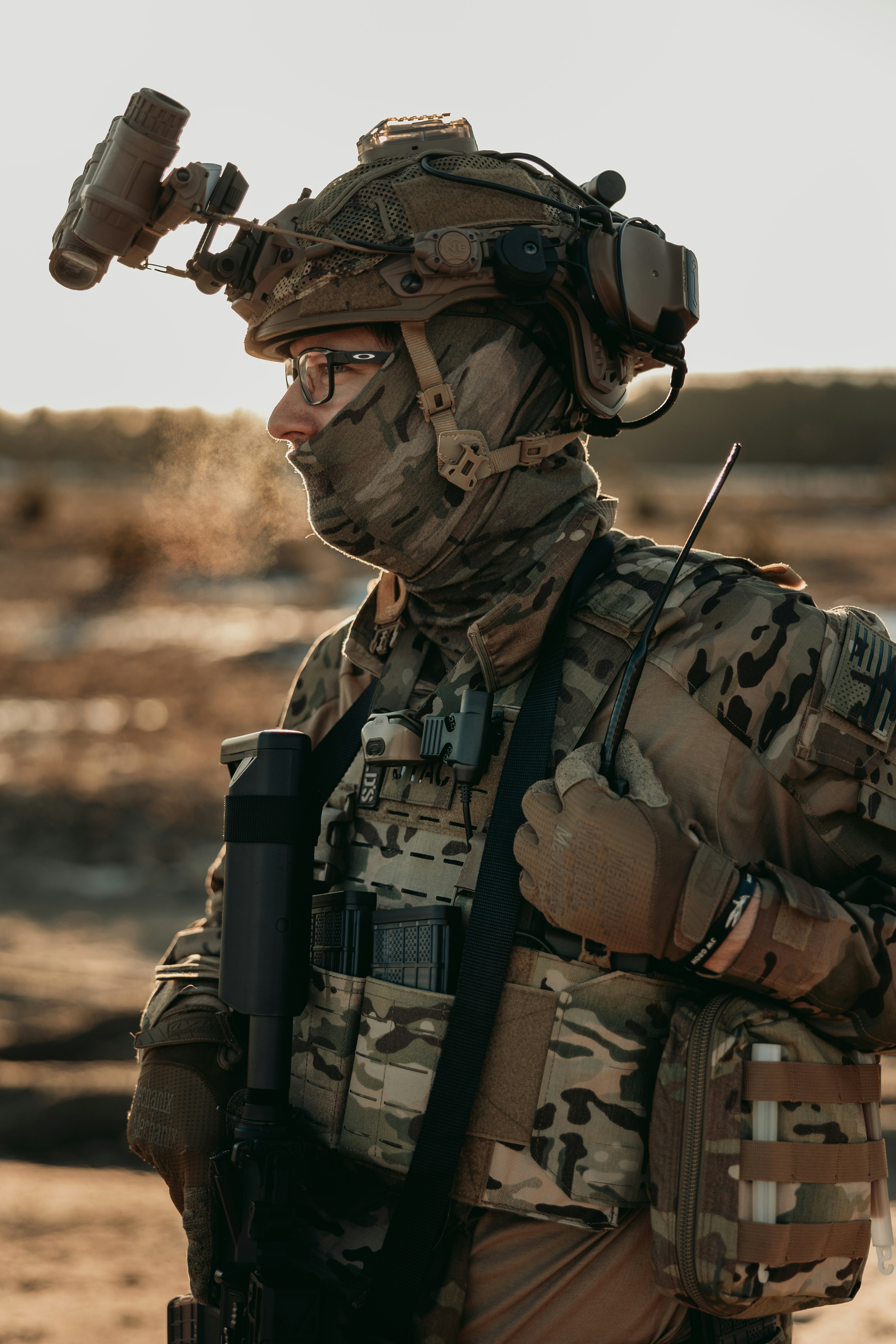 A soldier in full combat gear looks on. photo – Free Photo Image on ...