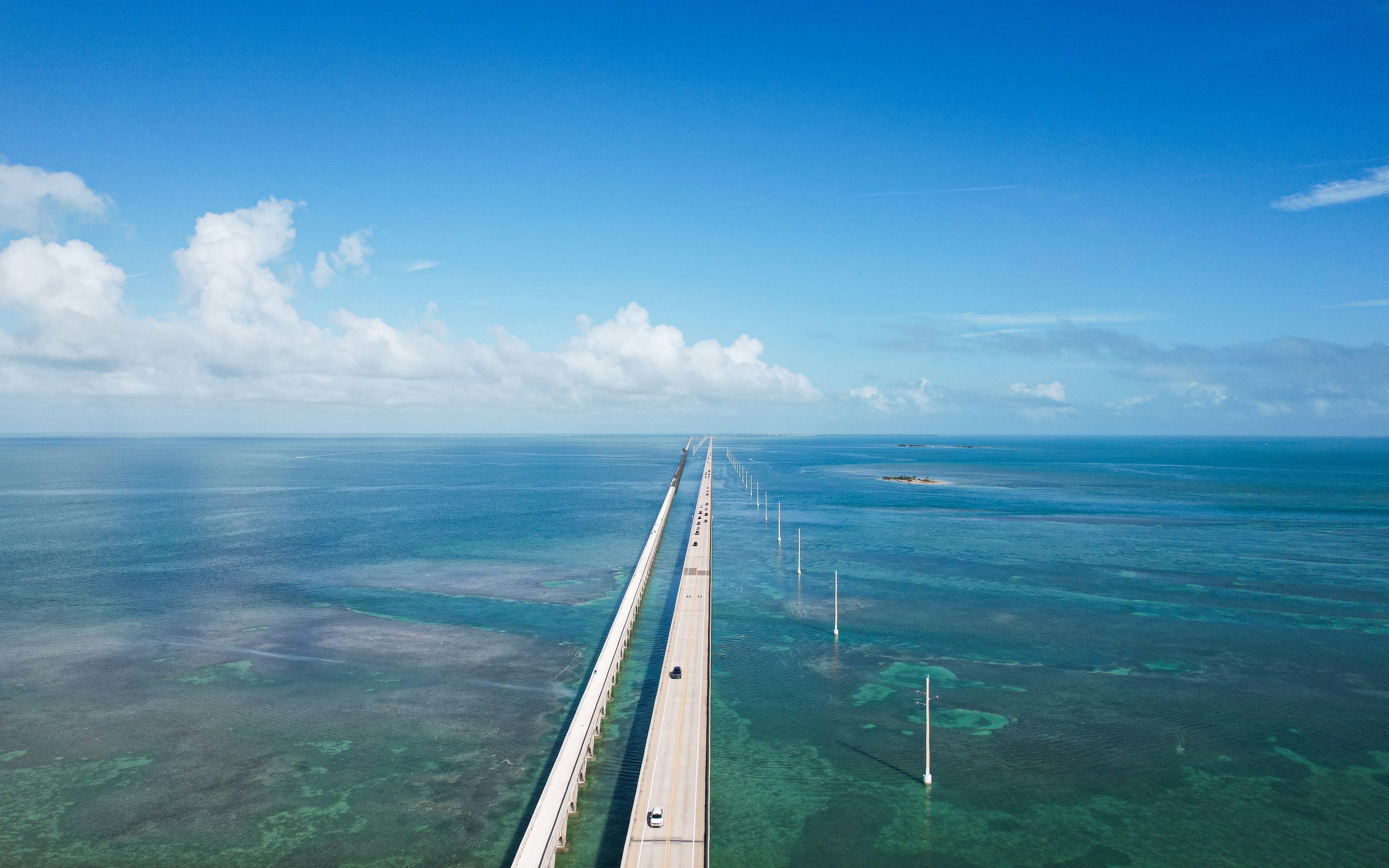 Aerial view of the historic Seven Mile Bridge stretching across the clear, turquoise waters of the Florida Keys.