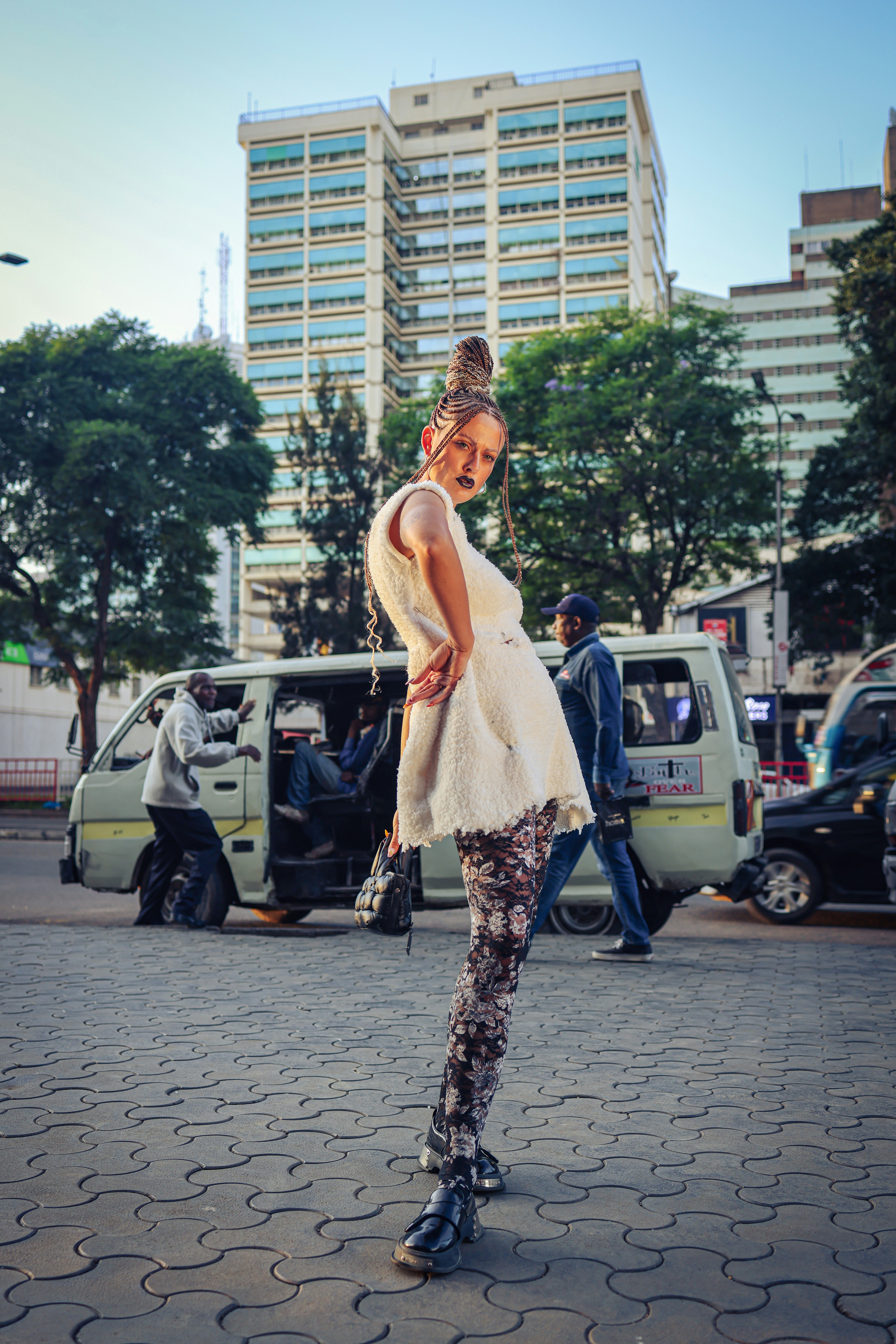 A woman poses fashionably on a busy street. photo – Free Woman Image on ...