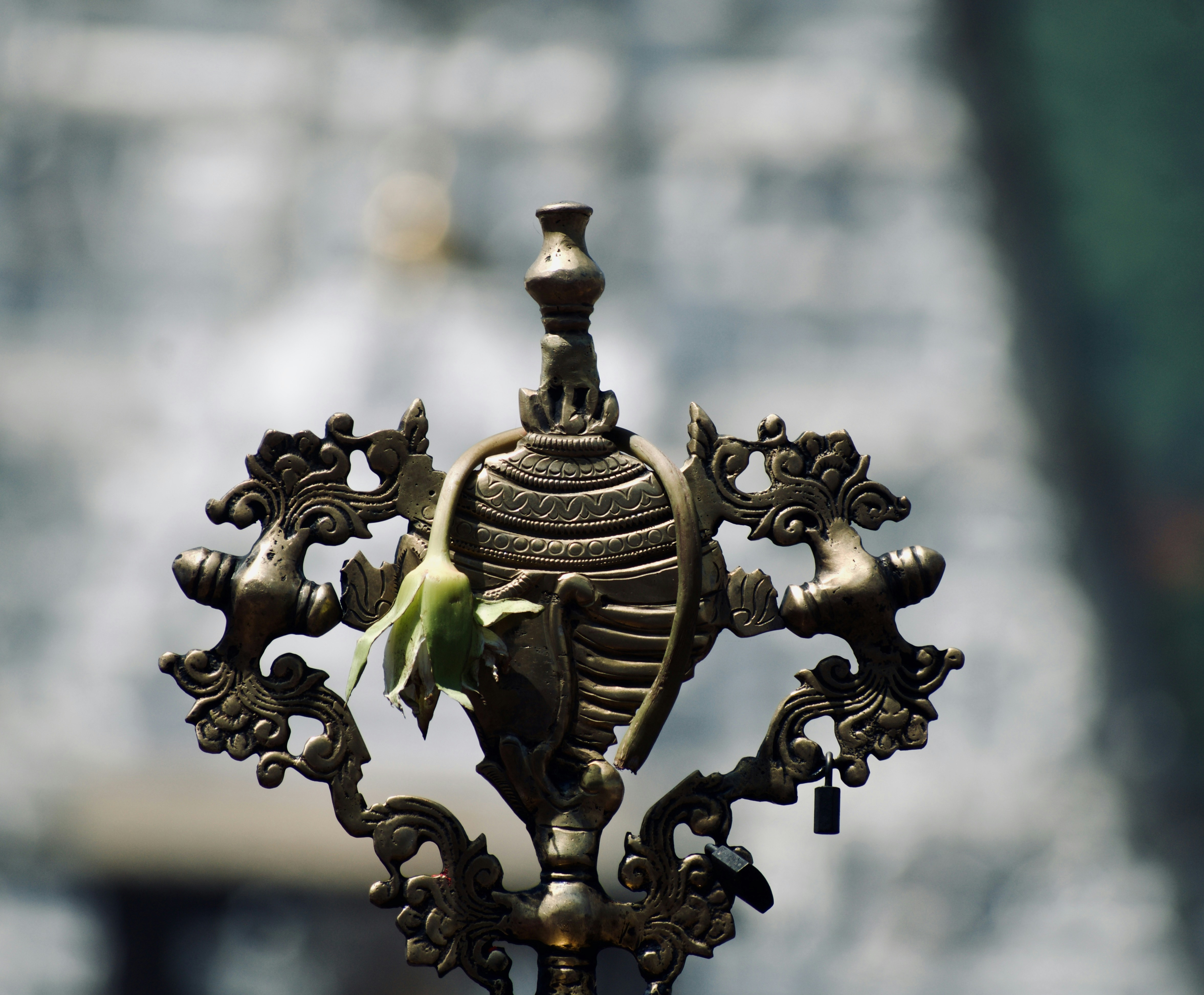Ornate Lamp Post with Budding Flower: A Focus on Craft and Quiet Detail