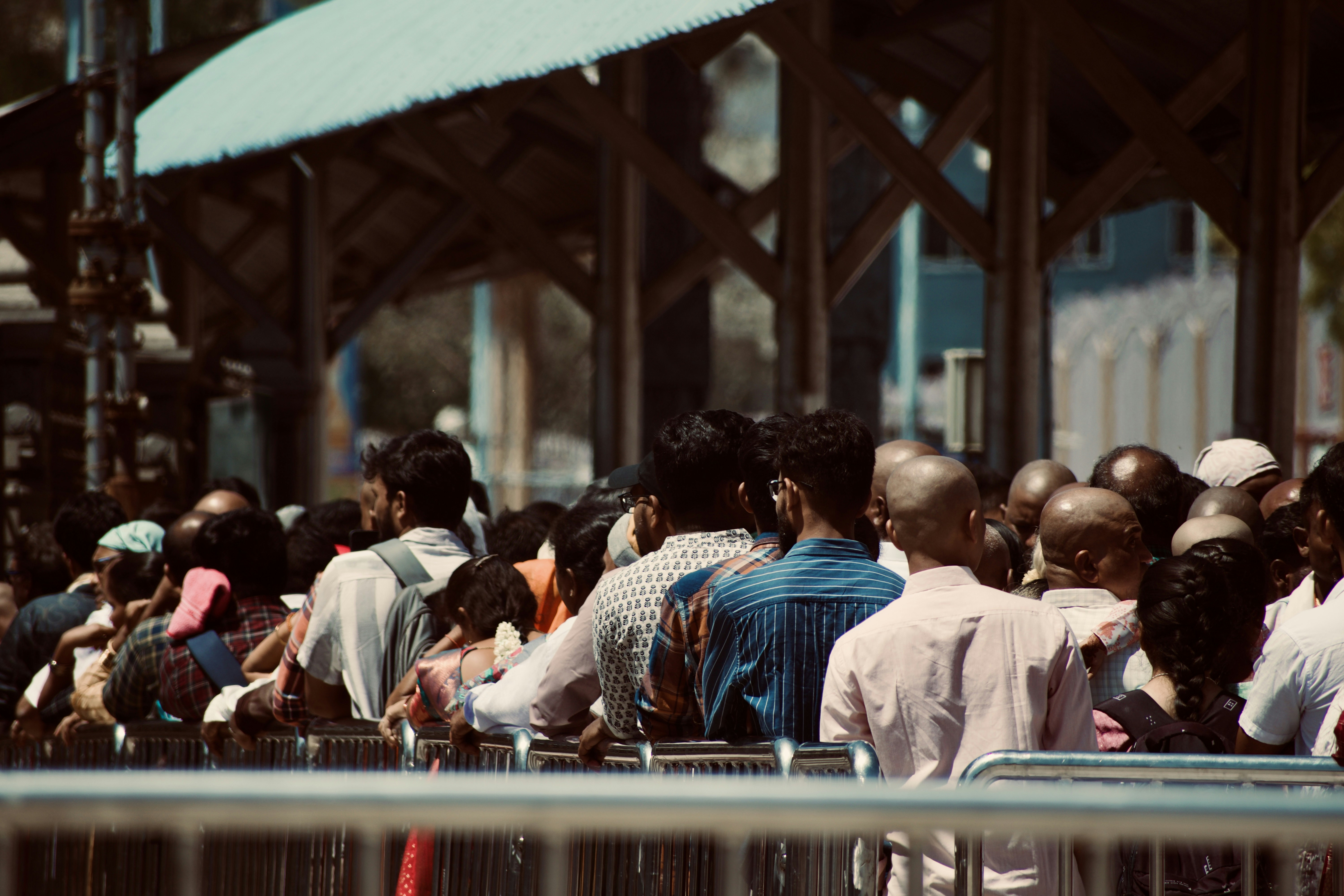 People are waiting in a long, crowded line. photo – Free Woman Image on ...