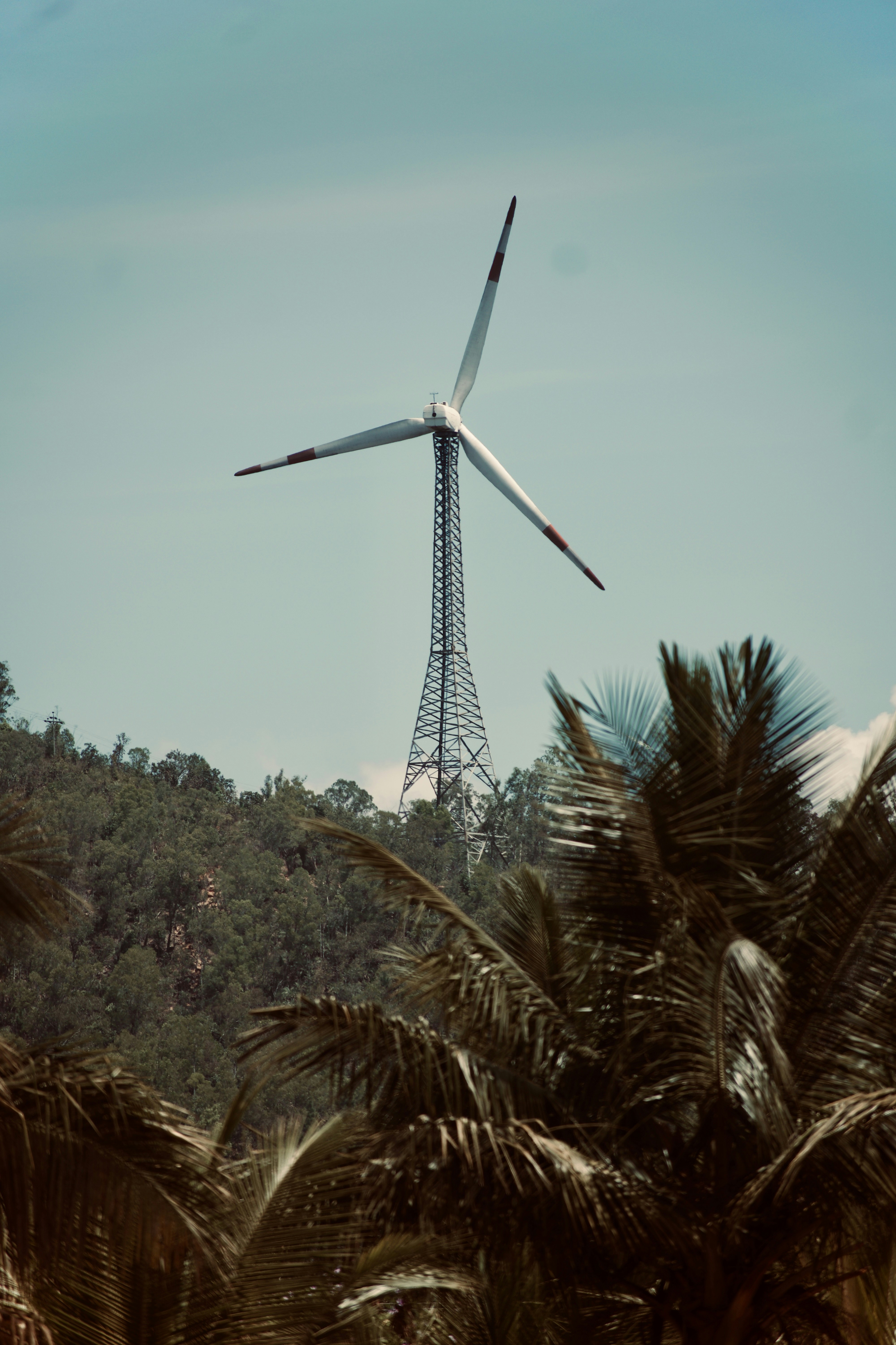 Wind Giant: A Wind Turbine Piercing a Sky-Blue Crest