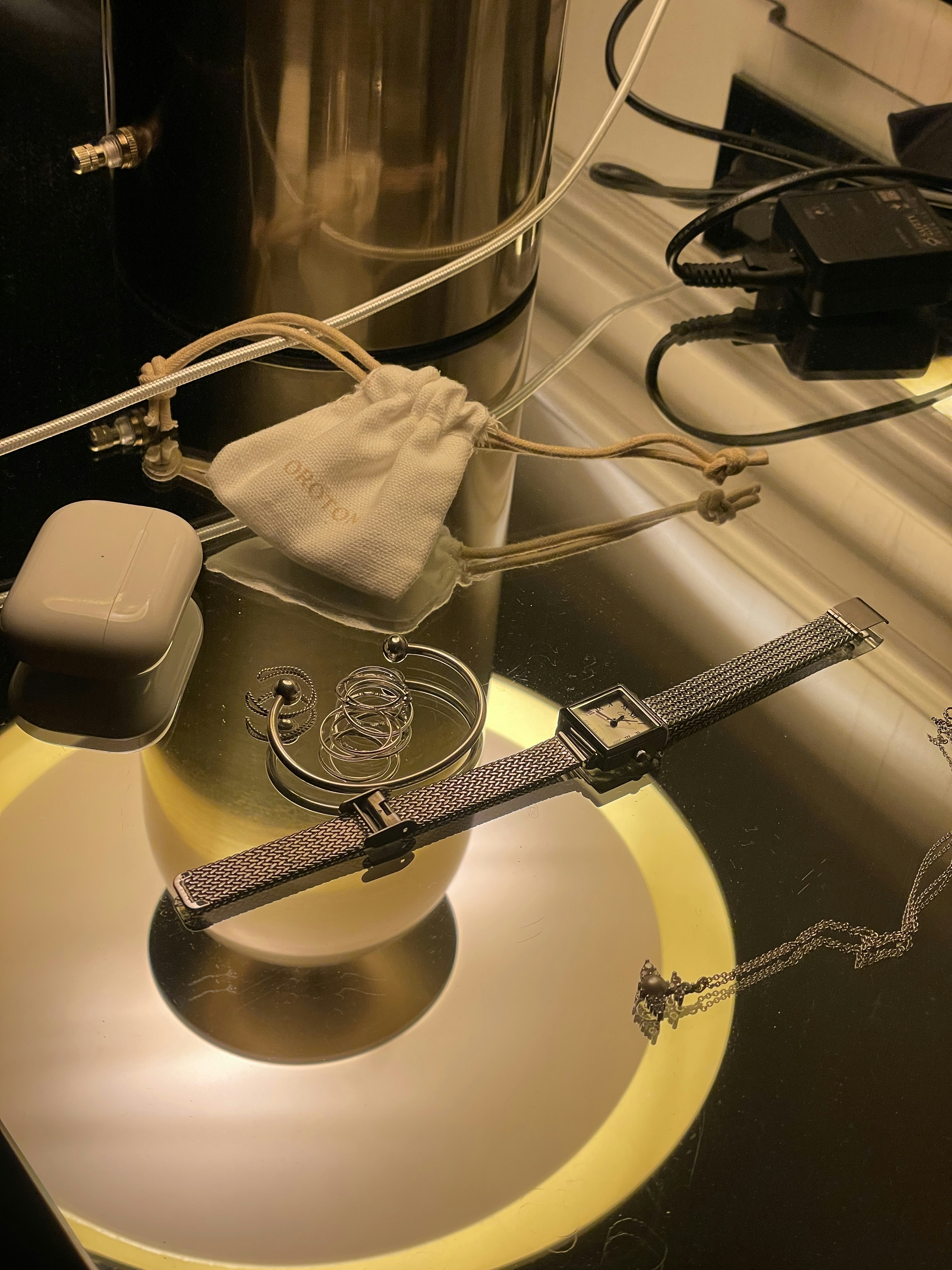 Reflection and Precision: A Slim Wristband Resting Across a Circular Glow