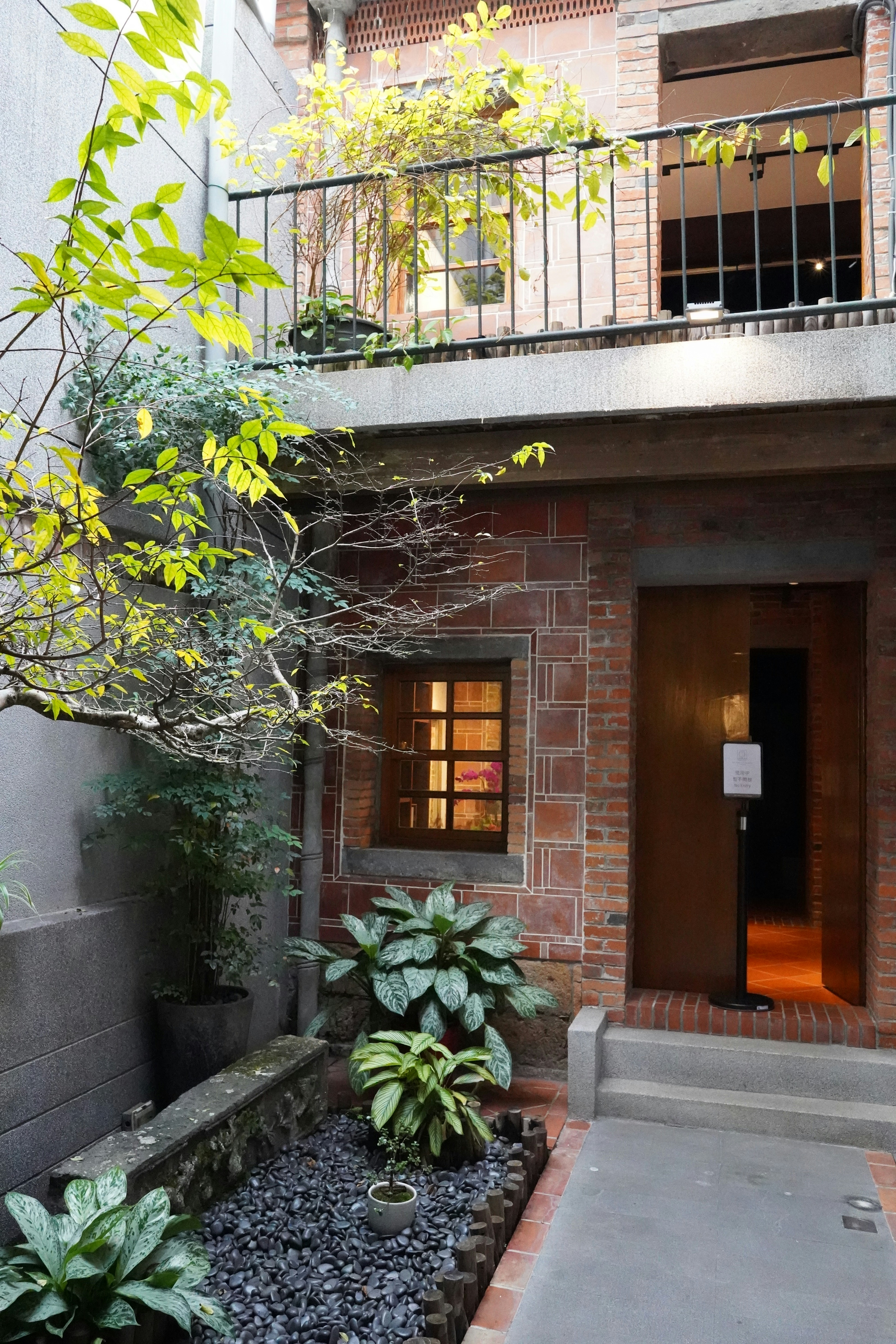 Brick Courtyard Portal with Greenery and Soft Interior Glow
