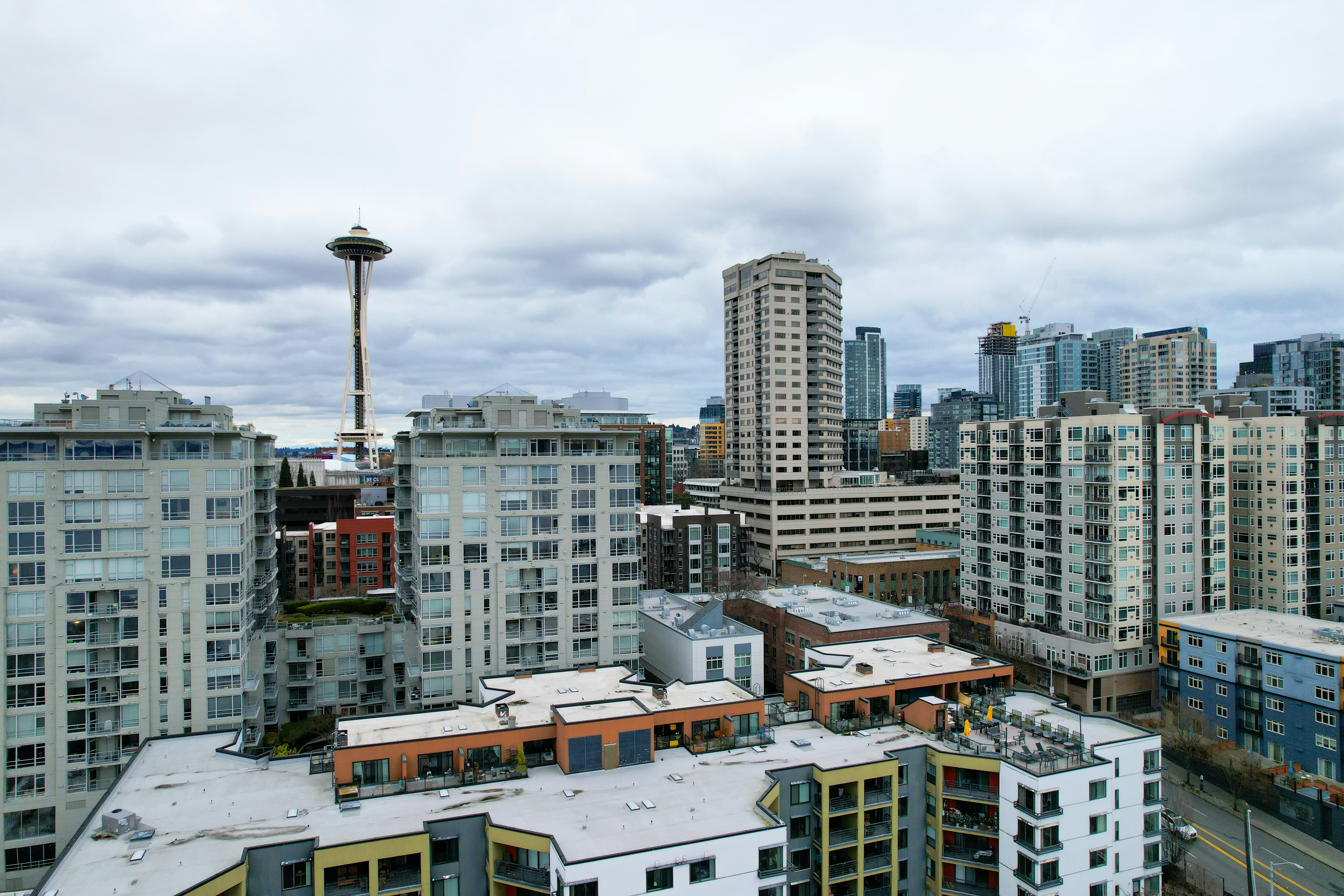 This image showcases the iconic Space Needle, a defining symbol of Seattle's skyline and a marvel of mid-20th-century architecture. Built for the 1962 World's Fair, the 605-foot structure was designed to resemble a flying saucer, reflecting the era's fascination with space exploration. | A view of a city with tall buildings