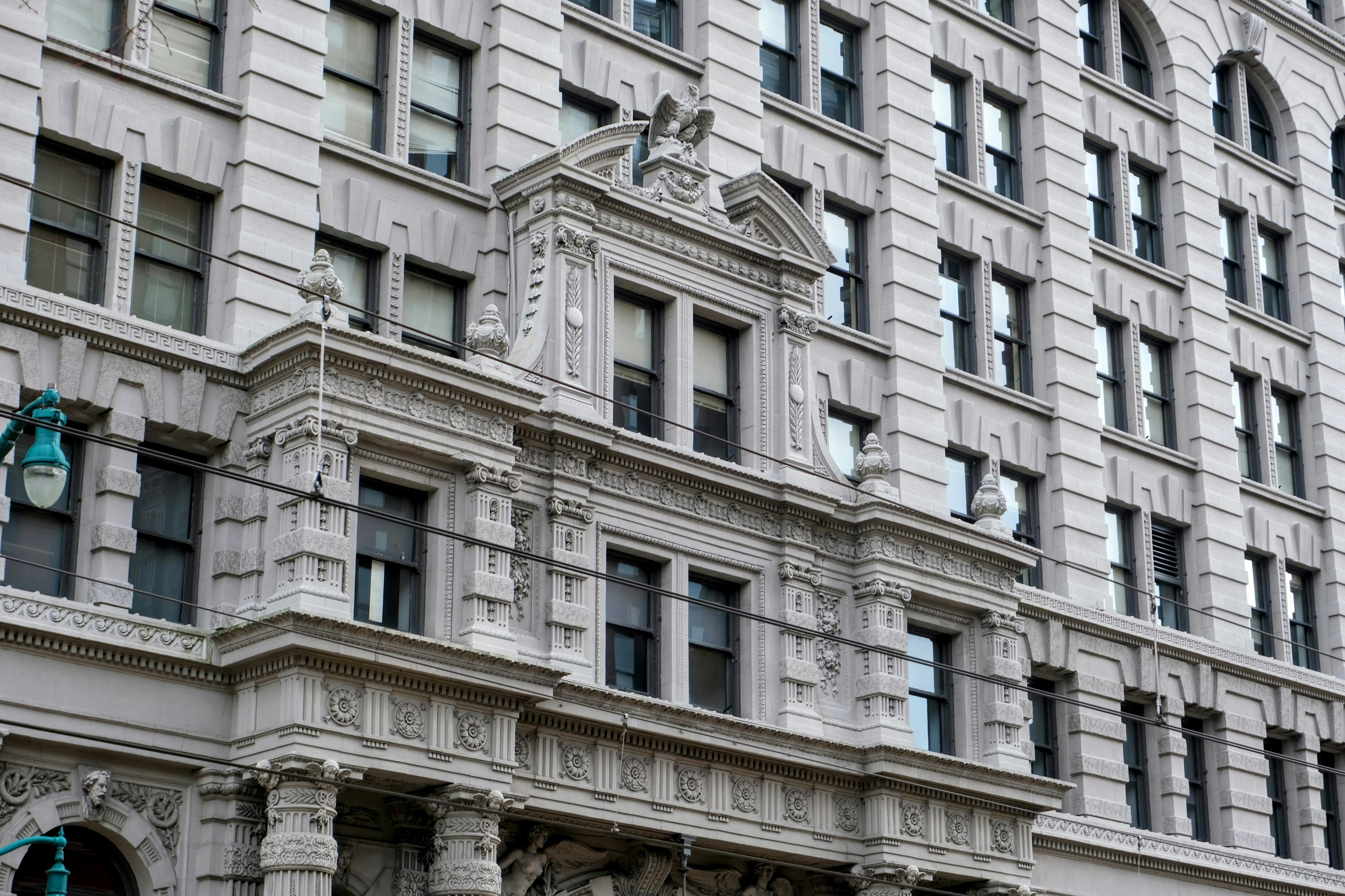 A detailed view of an ornate, stone building facade. photo – Free ...