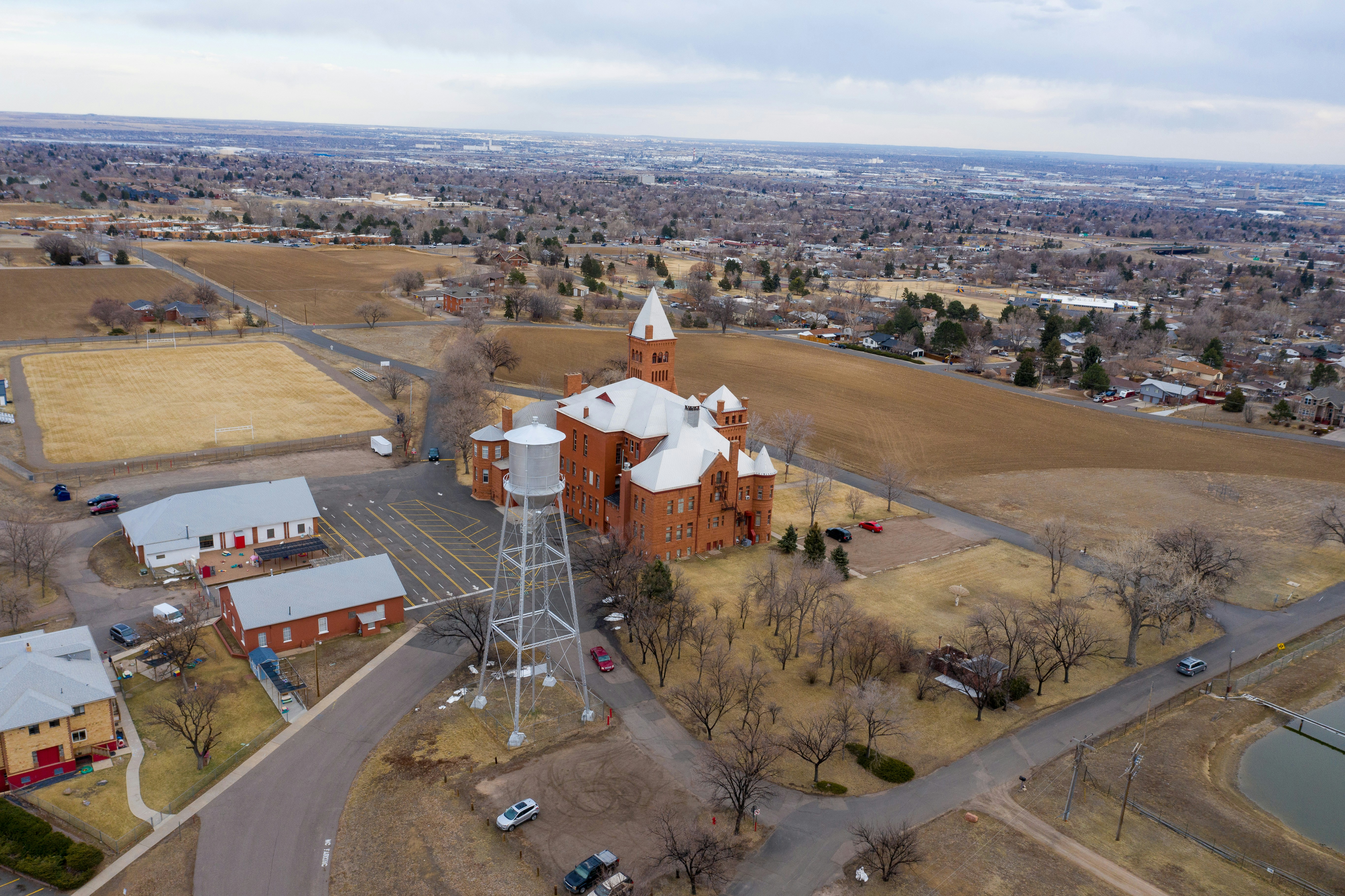 A brick building sits next to a water tower.