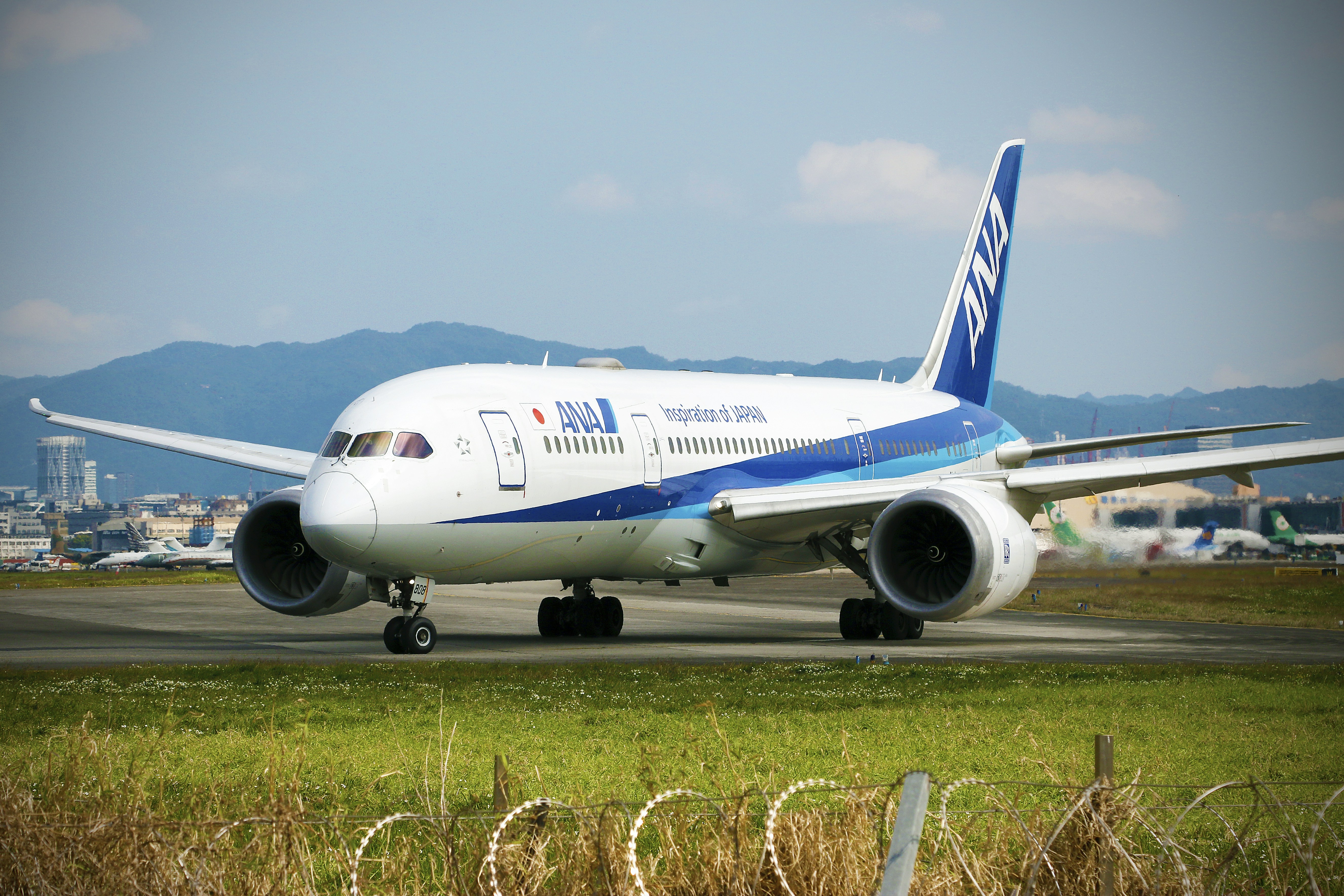 Jetliner Poised for Takeoff Amidst Mountain Backdrop