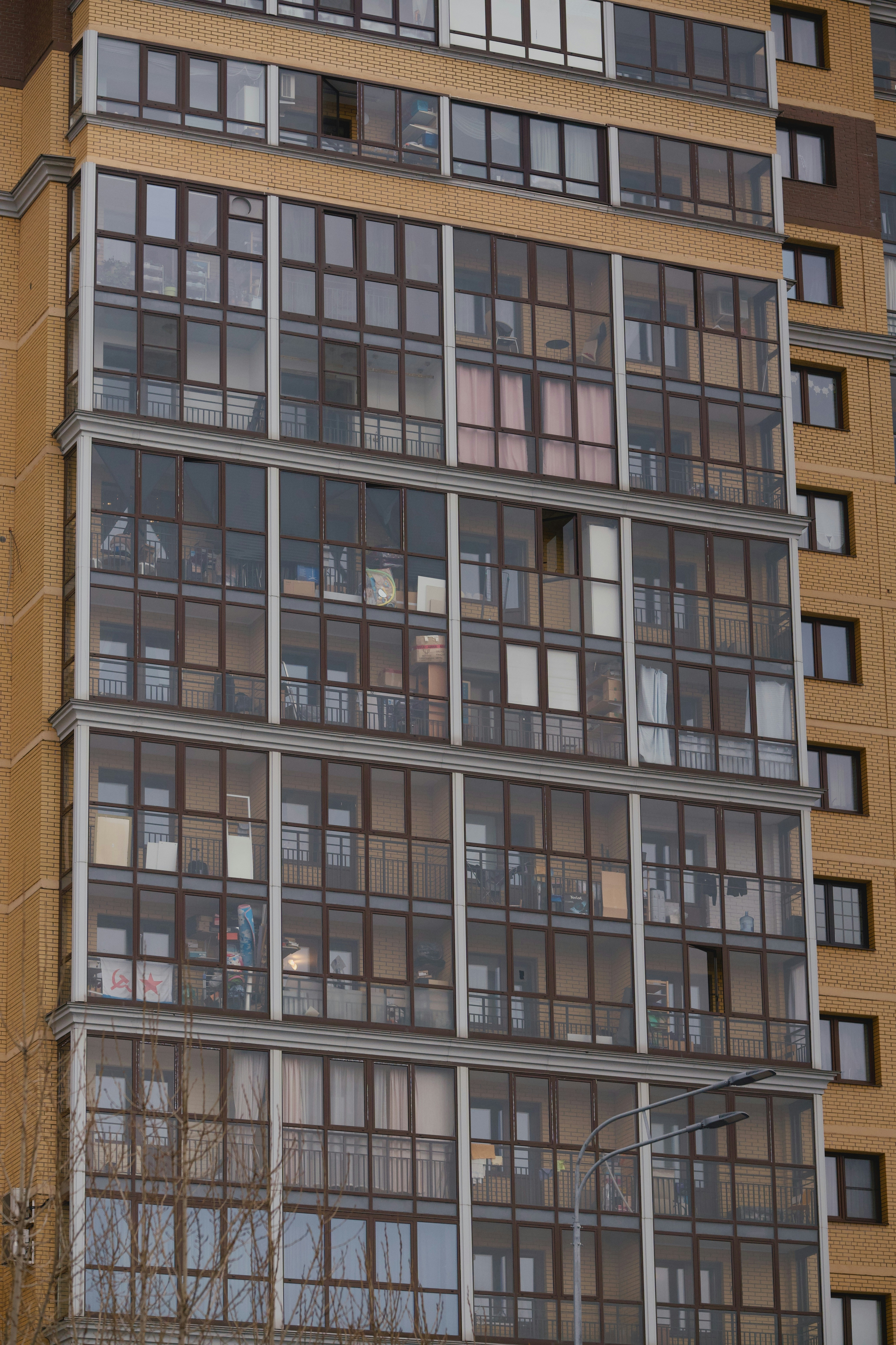 Tall apartment building with many glass windows. photo – Free Building ...