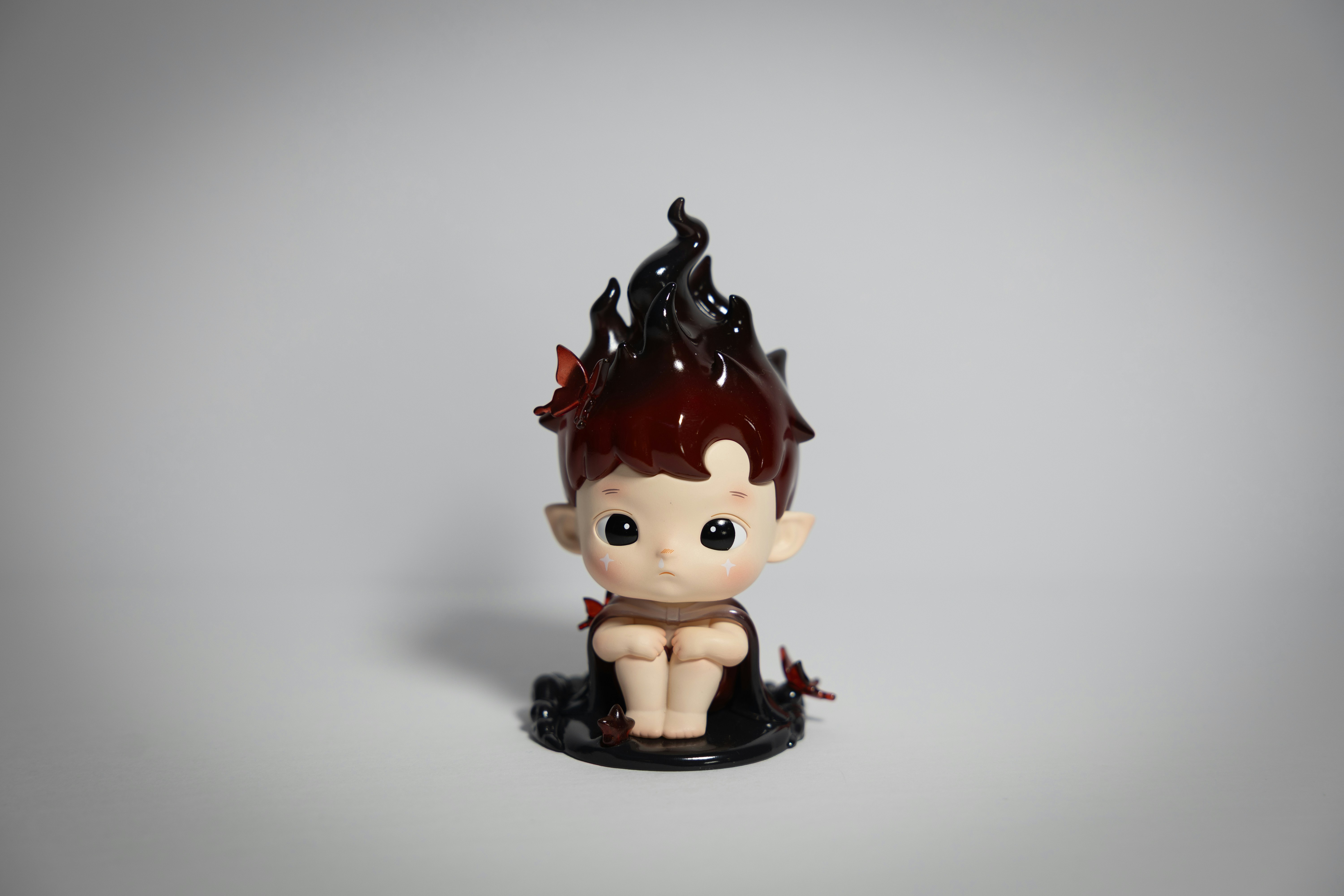 Emberbound Tiny: A Flame-Haired Figurine in a Quiet Studio