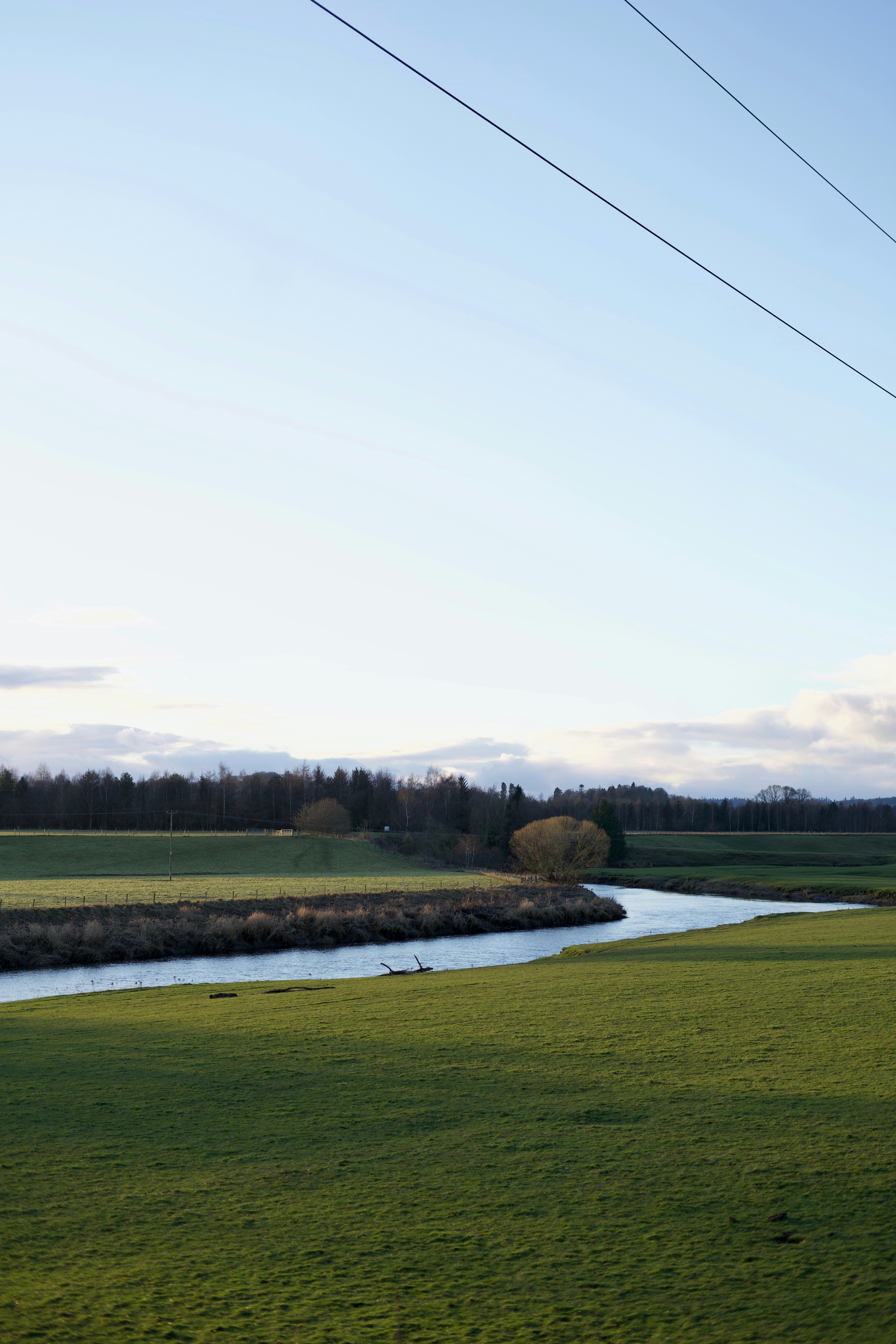A winding river flows through a green field. photo – Free Land Image on ...