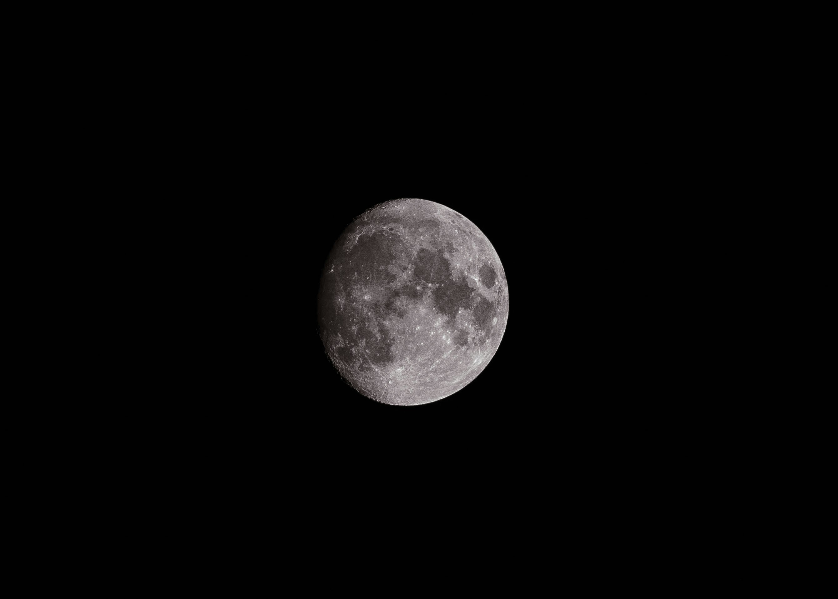 Crisp view of the moon against a dark sky, highlighting its craters and surface details.