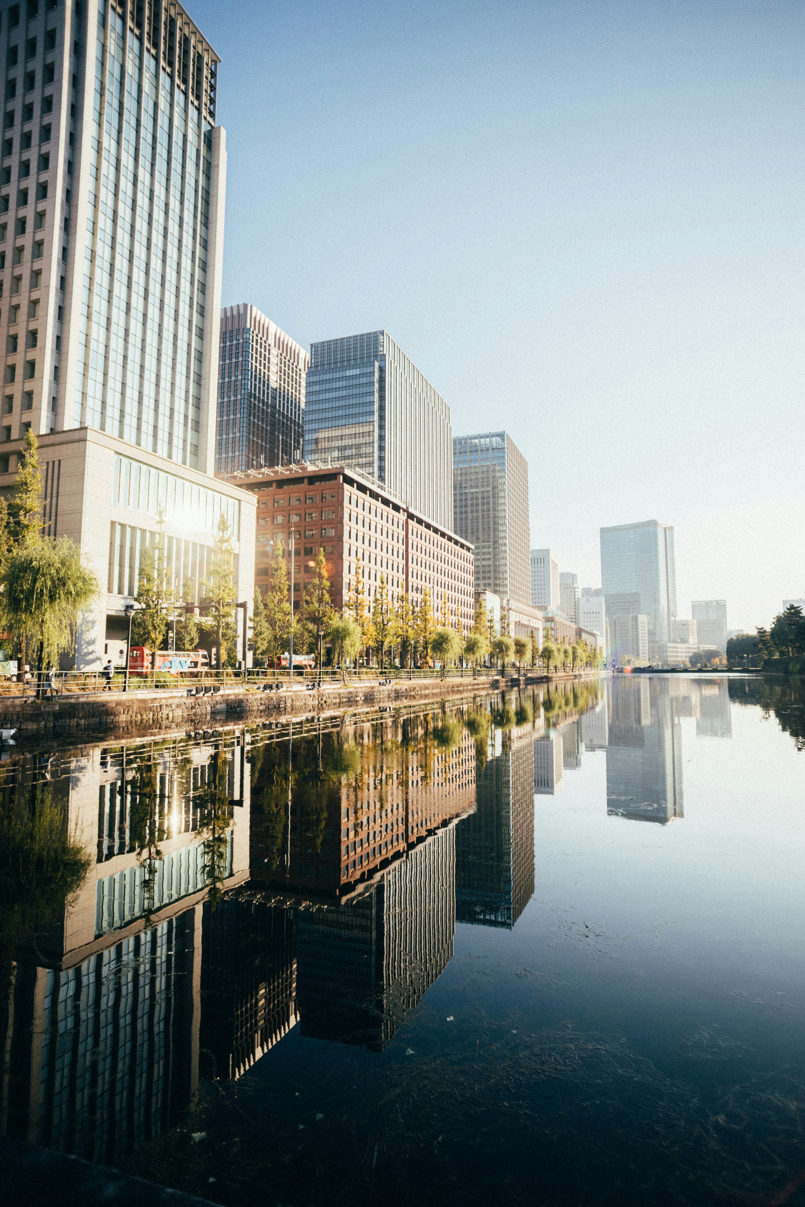 Cityscape buildings reflected in the serene water. photo – Free ...