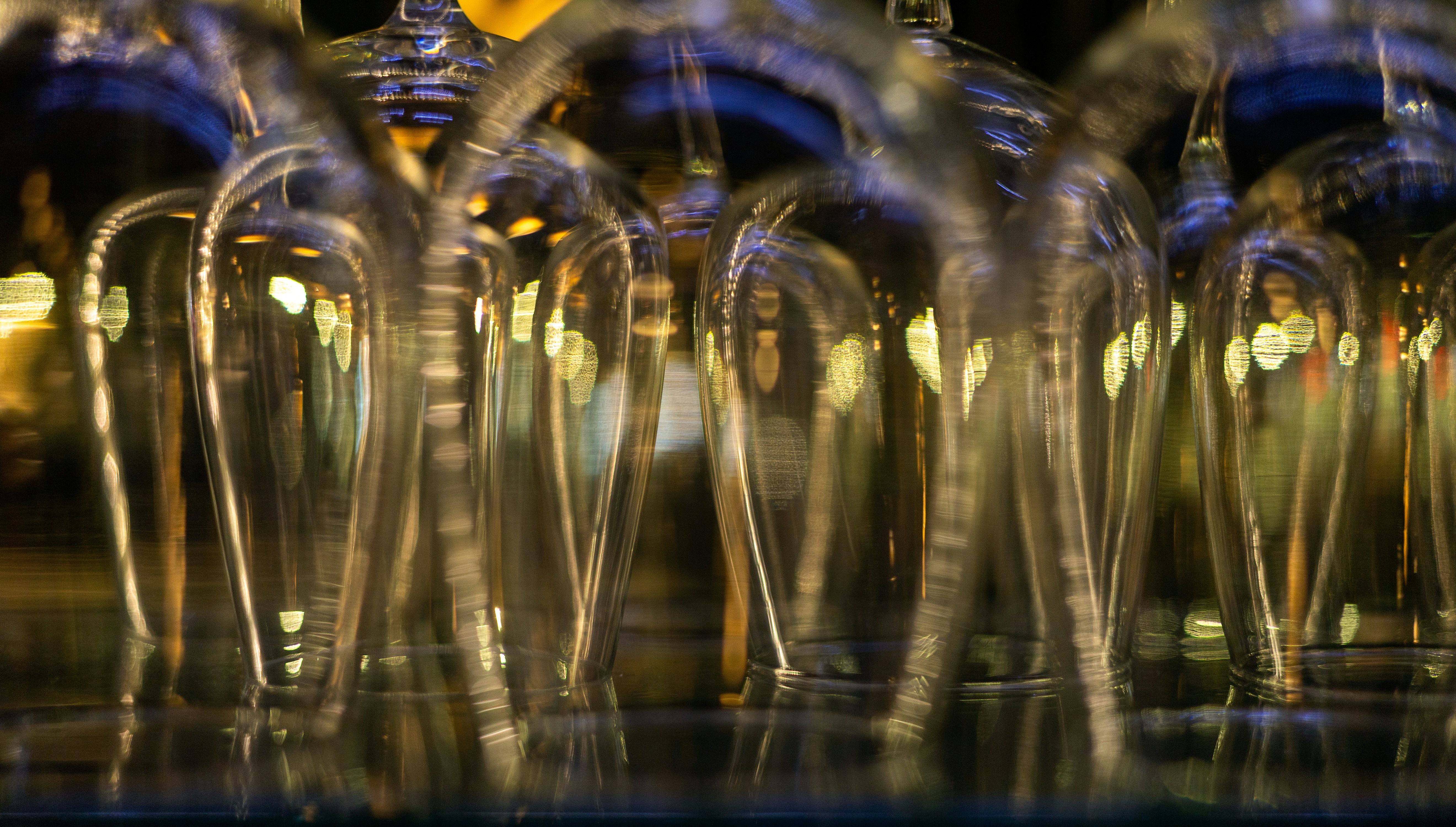 wine glasses | Wine glasses are illuminated in a row.
